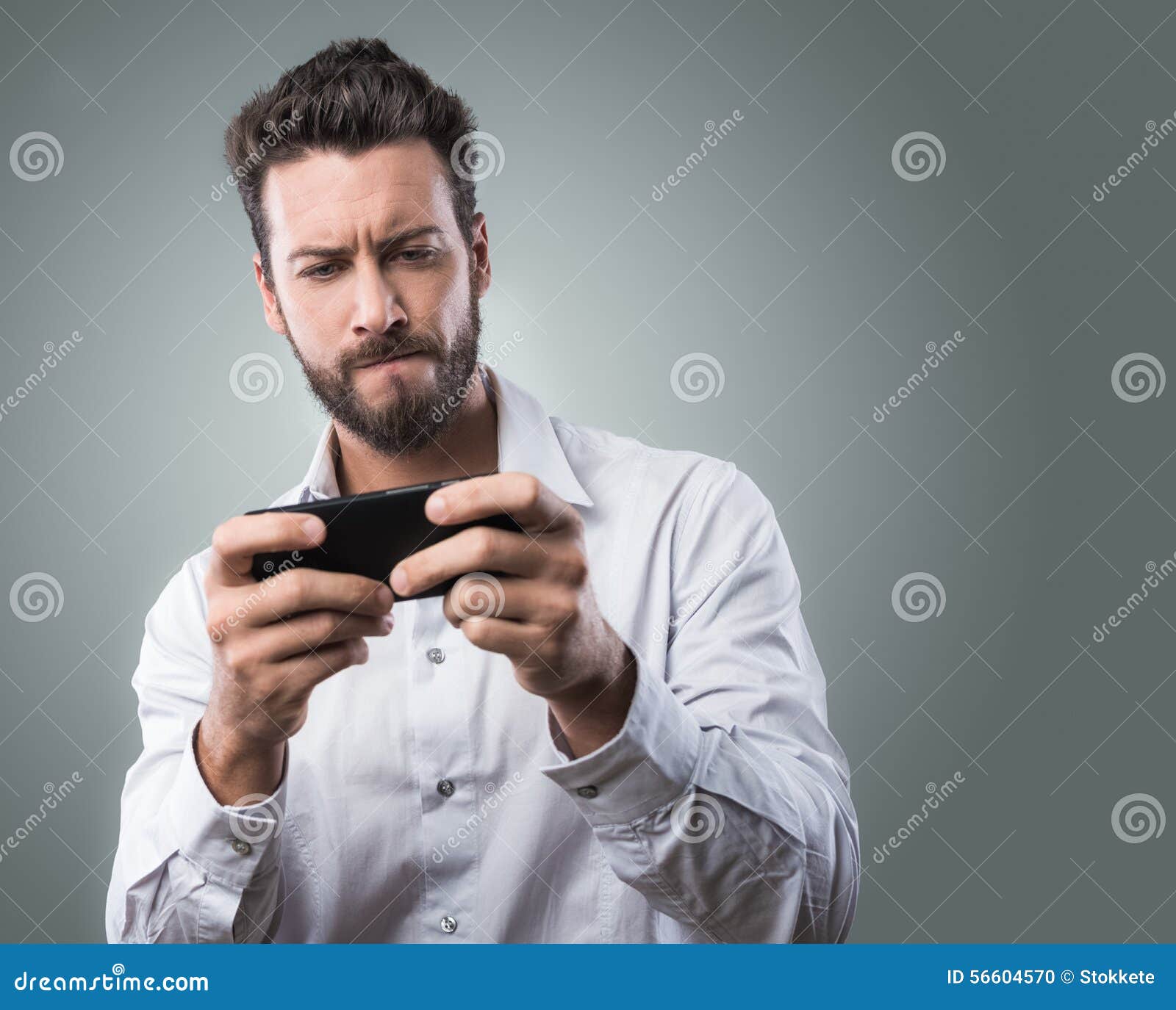 Handsome Man Playing with His Smartphone Stock Photo - Image of young ...