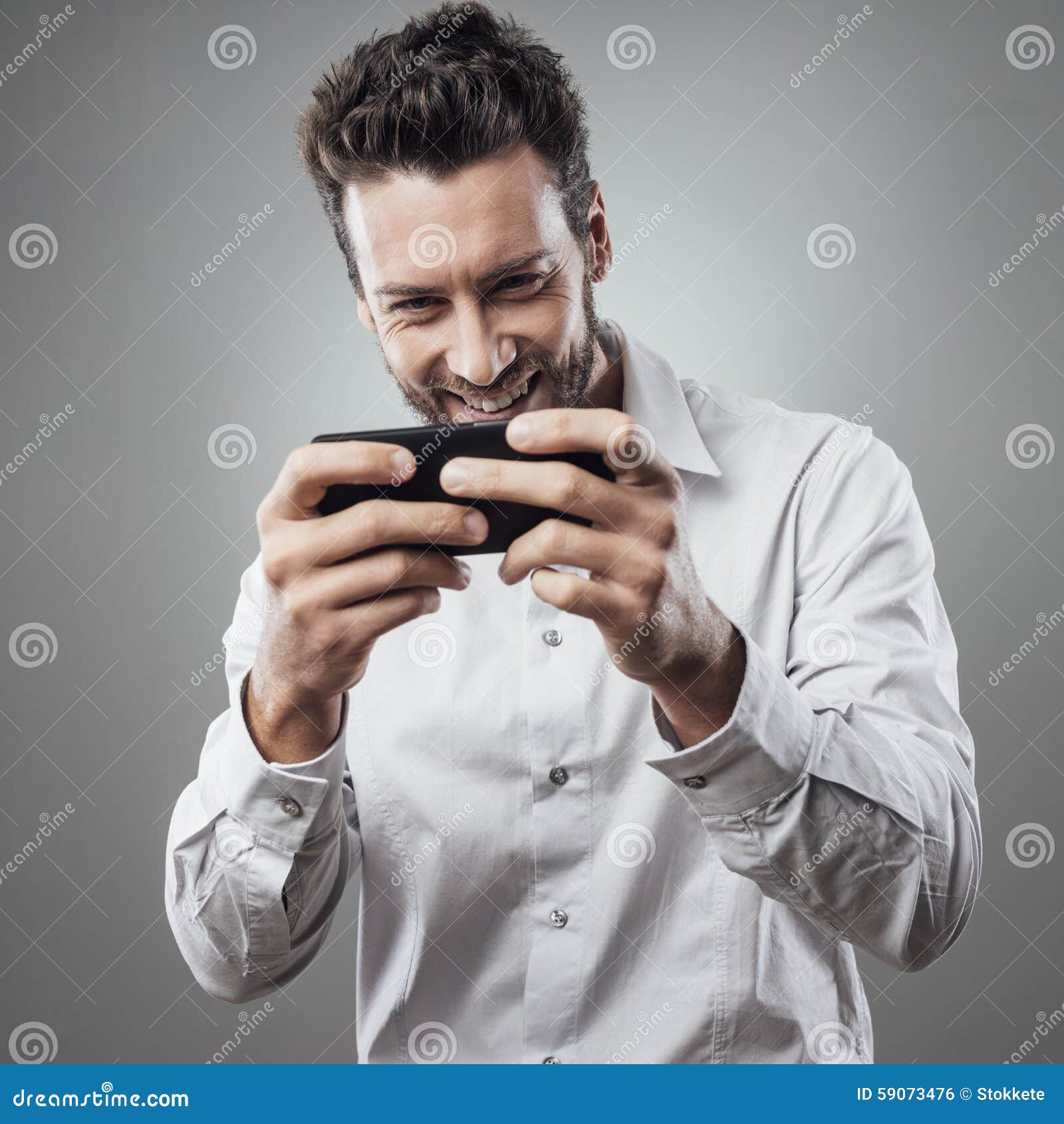 Handsome Man Playing with His Smartphone Stock Photo - Image of ...