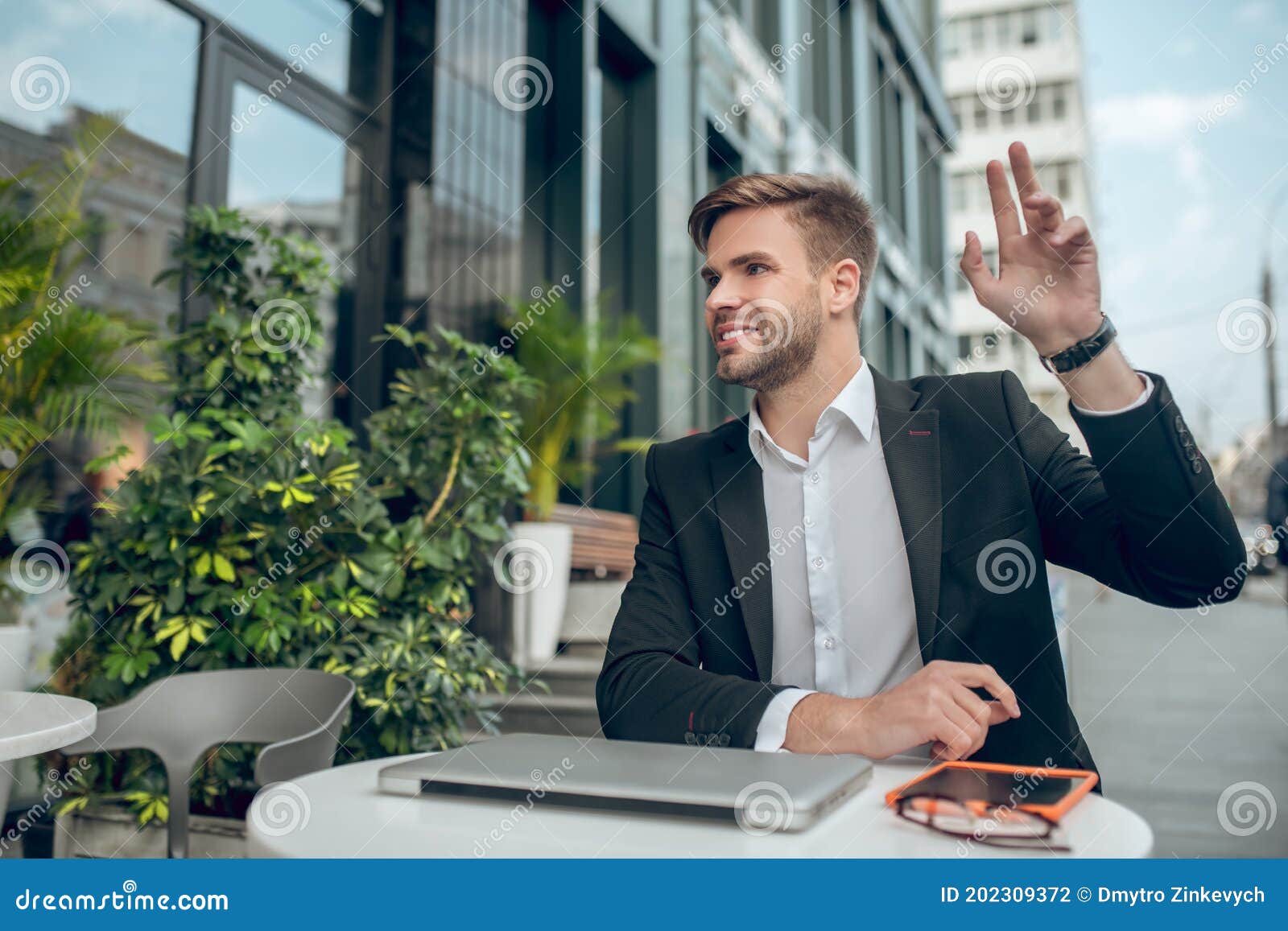 Handsome Man Raising His Hand Calling the Waiter Stock Photo - Image of ...