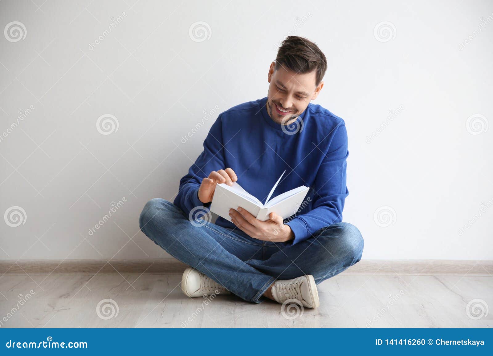 Handsome Man Reading Book on Floor Stock Photo - Image of entertainment ...