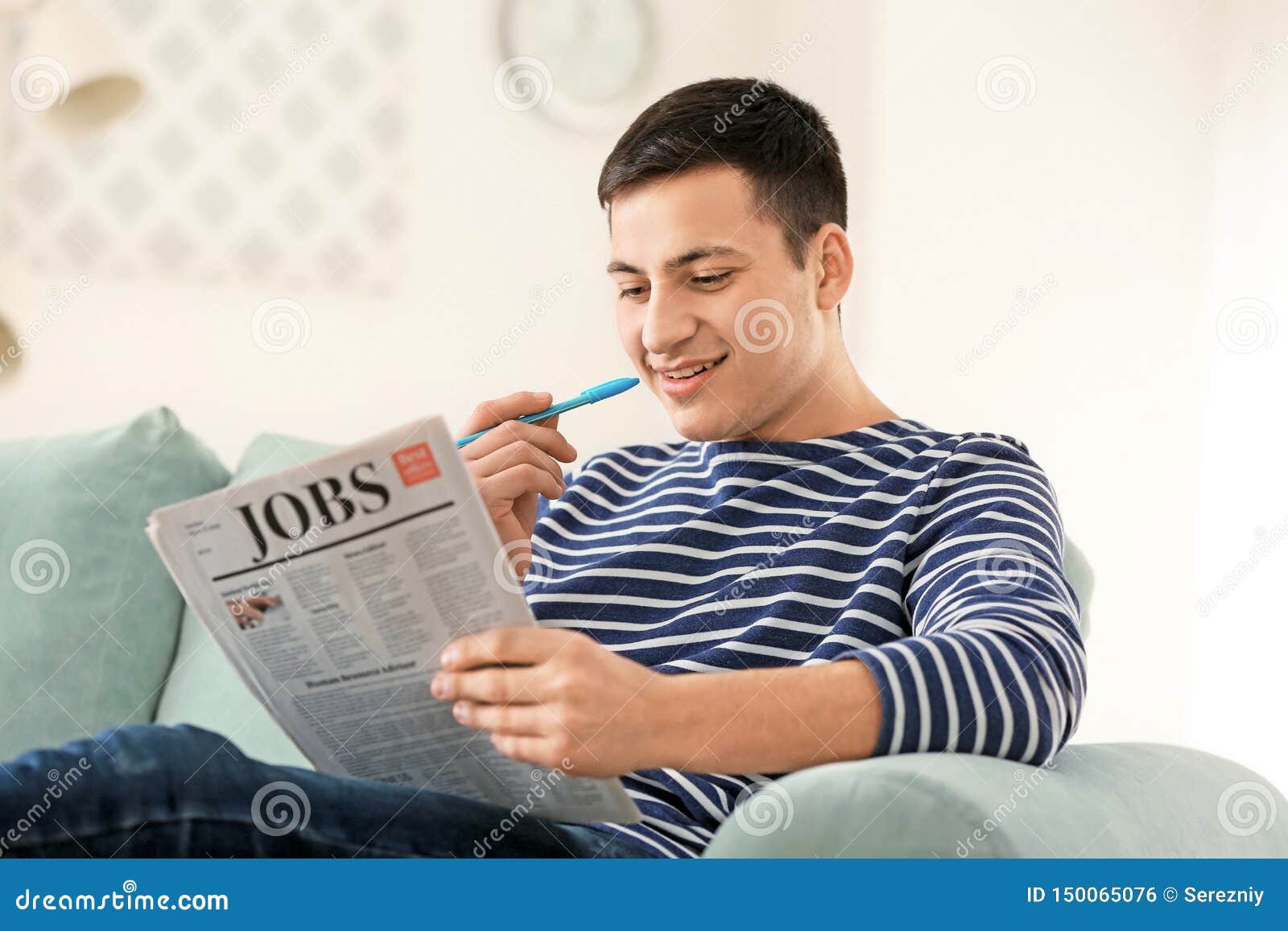 Handsome Man Reading Newspaper on Sofa at Home Stock Photo - Image of ...