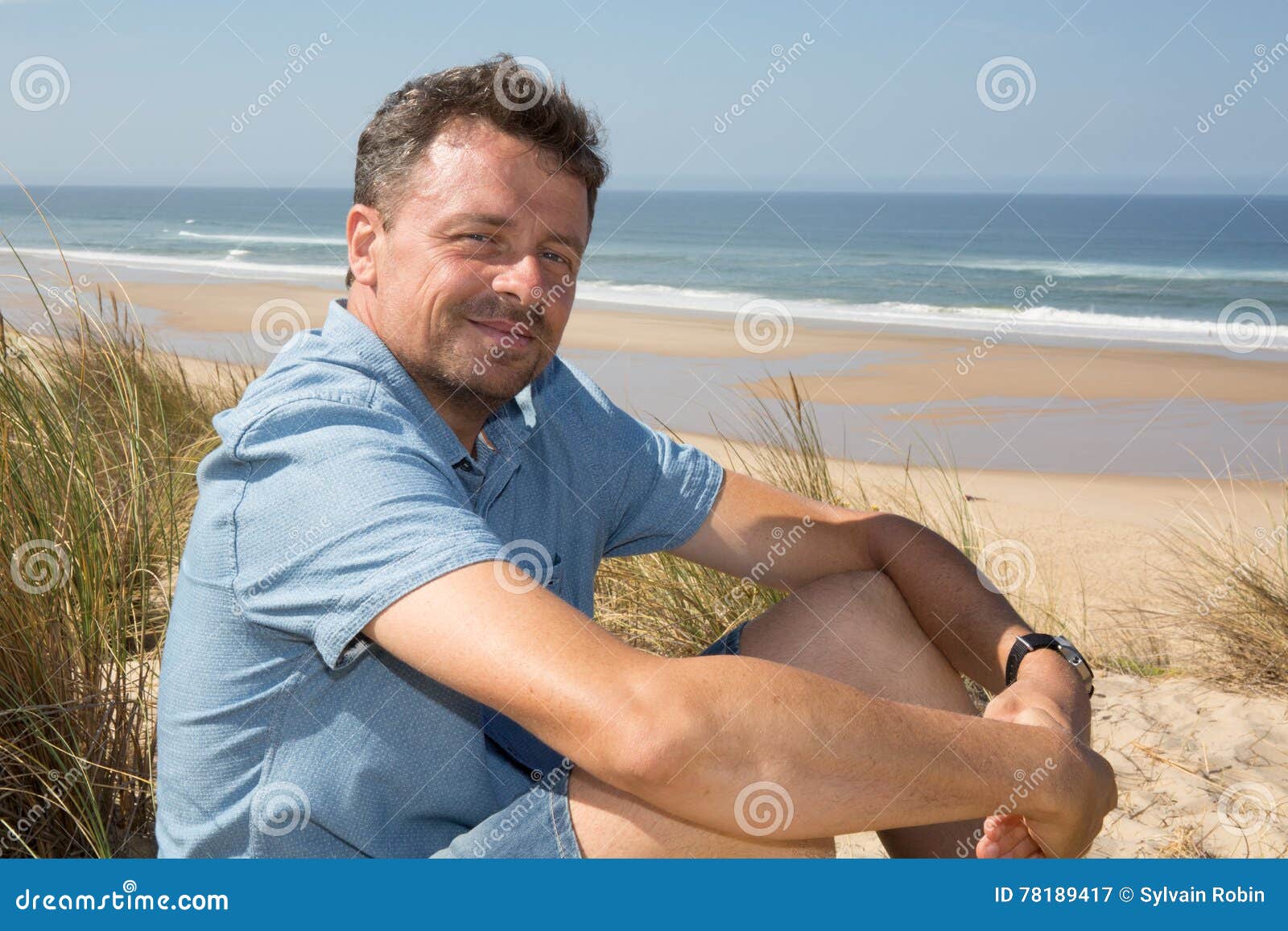 Handsome Man Relaxing on the Beach, Sitting on the Sand Stock Image ...