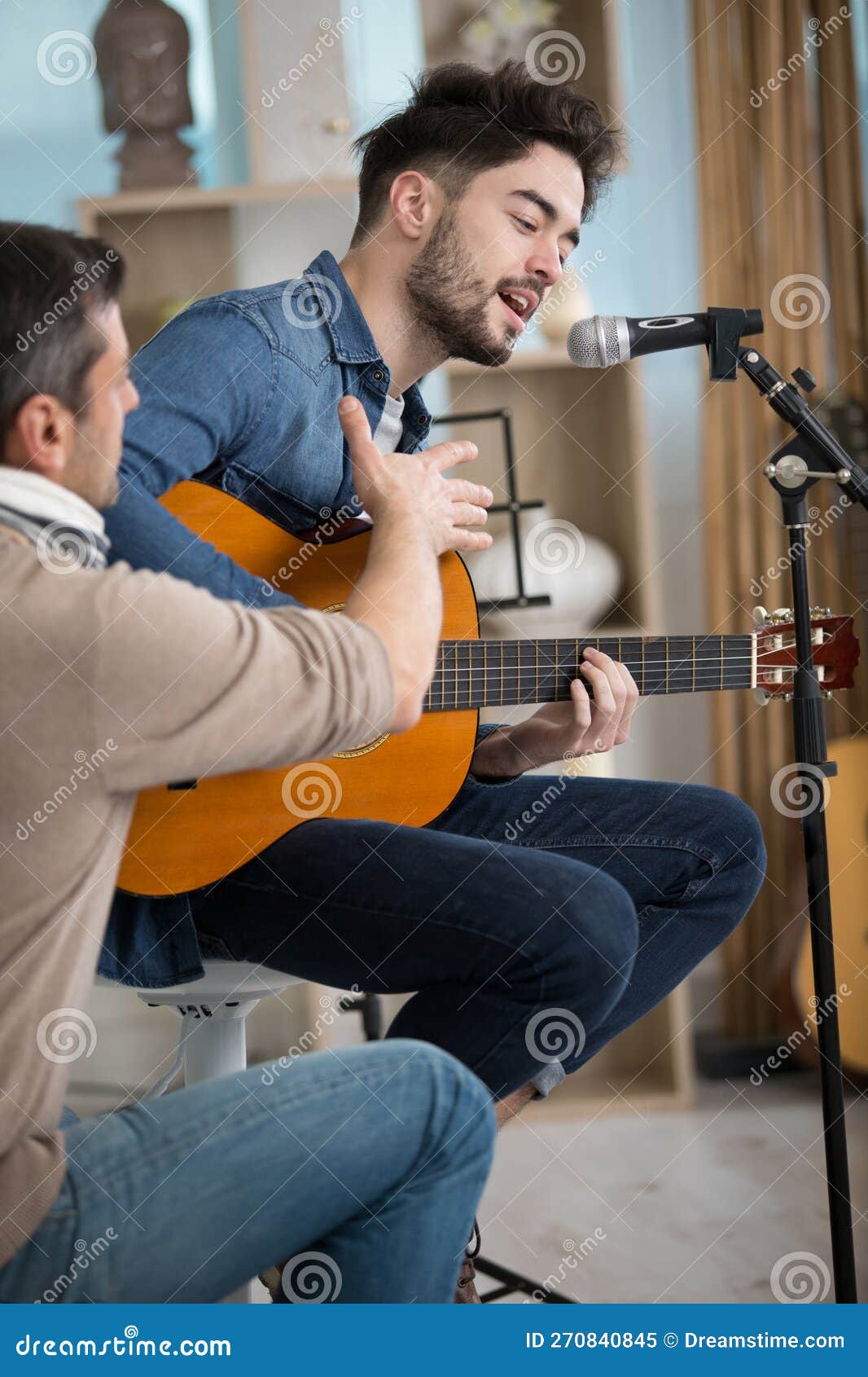 Handsome Man Sings while Playing Guitar at Home Toned Stock Image ...