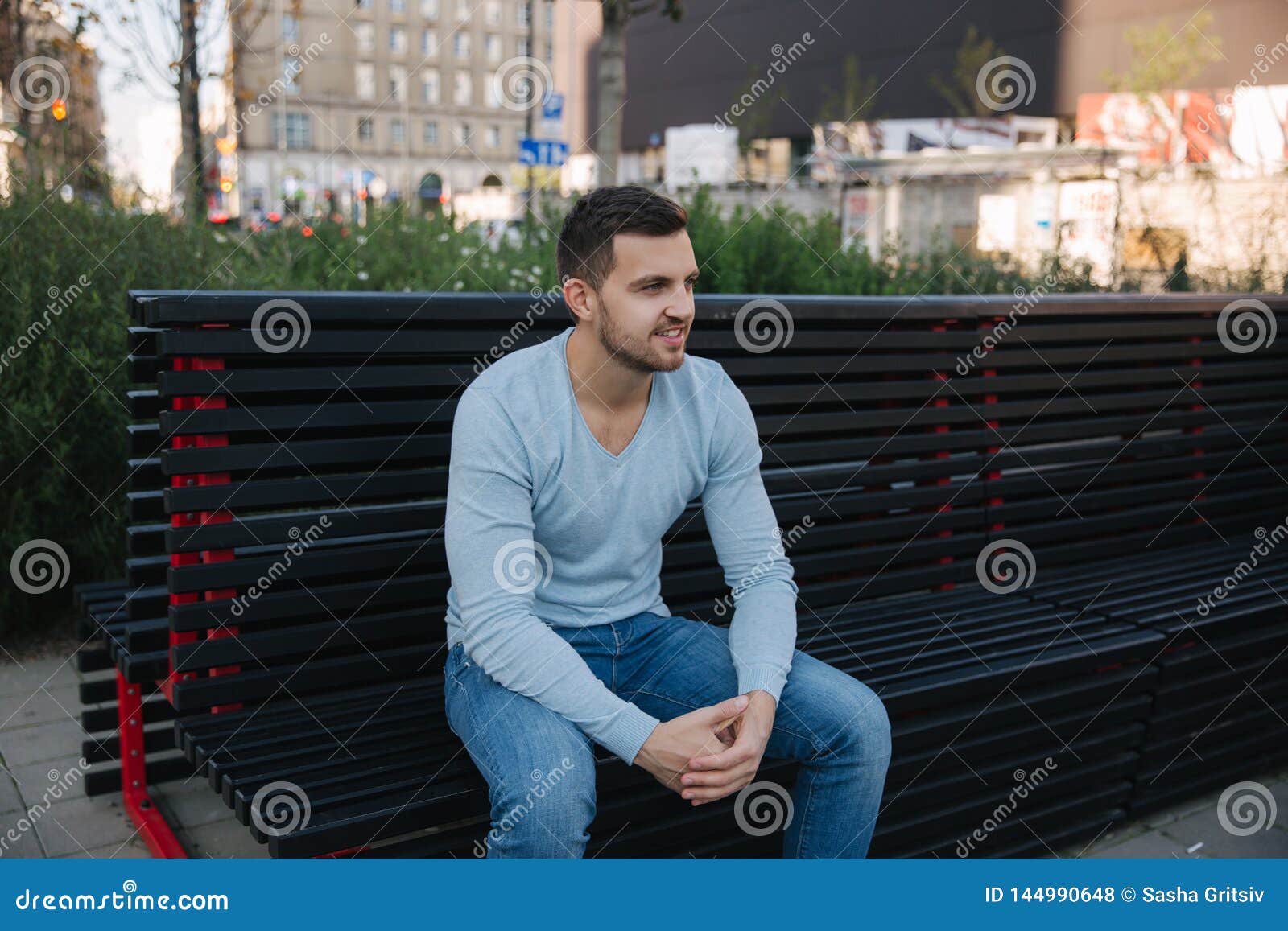 Handsome Man Sitting on the Bench in Centre of the City. Happy Man ...