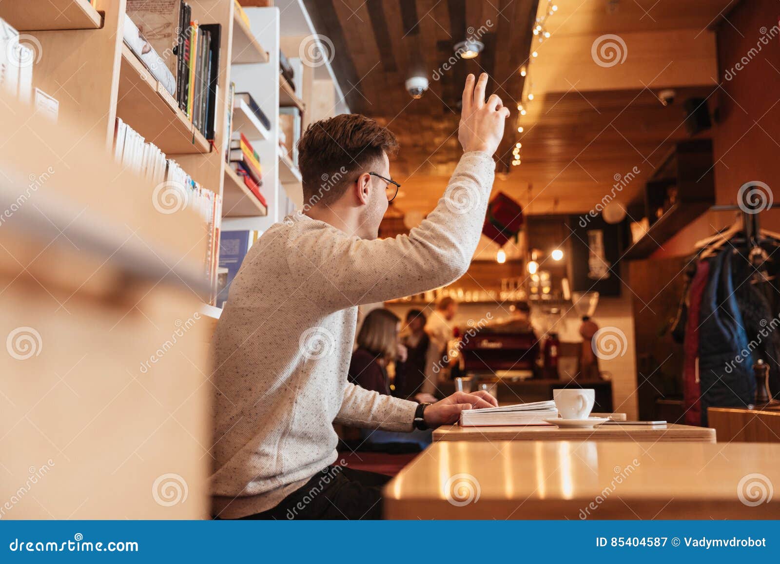 Handsome Man Sitting in Cafe while Call the Waiter. Stock Image - Image ...