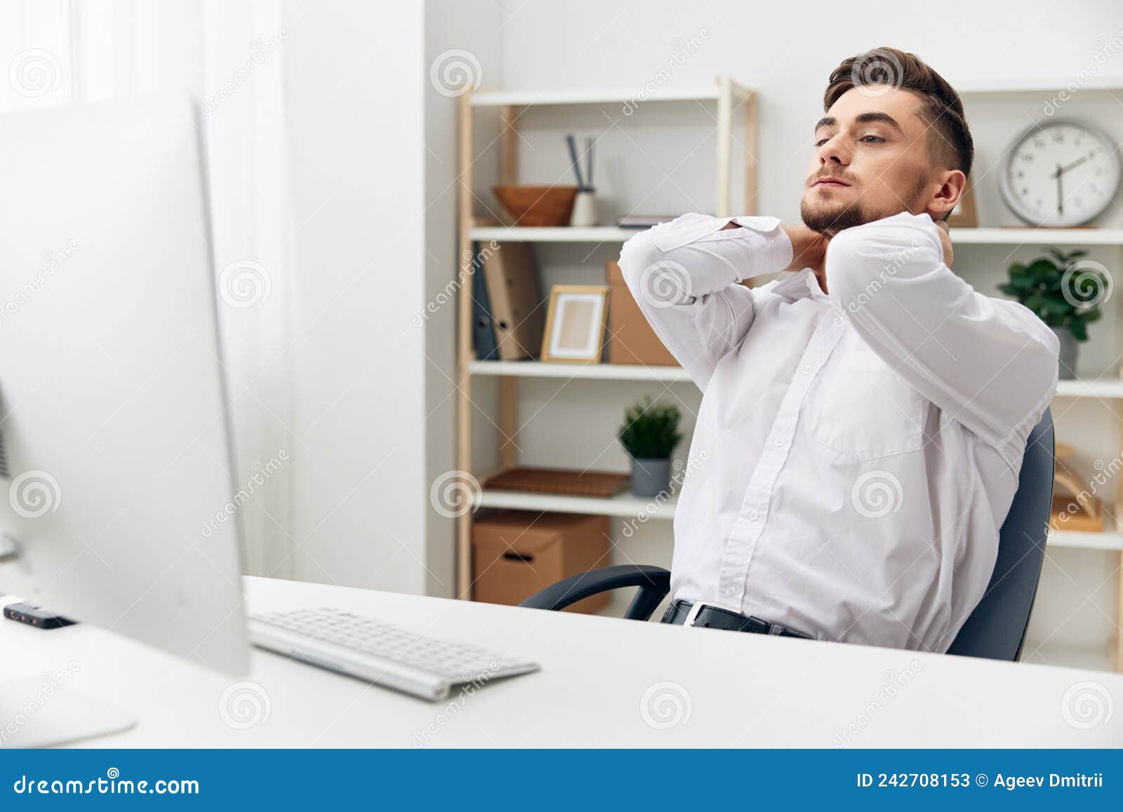 Handsome Man Sitting at a Desk in Front of a Computer with a Keyboard ...