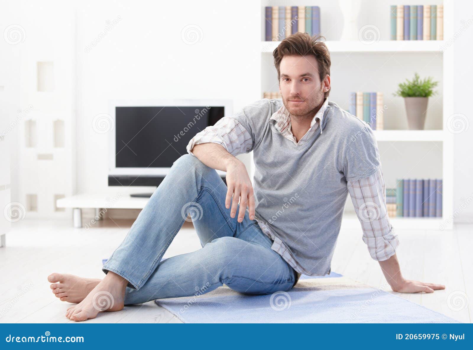 Handsome Man Sitting on Living Room Floor Stock Image - Image of floor ...