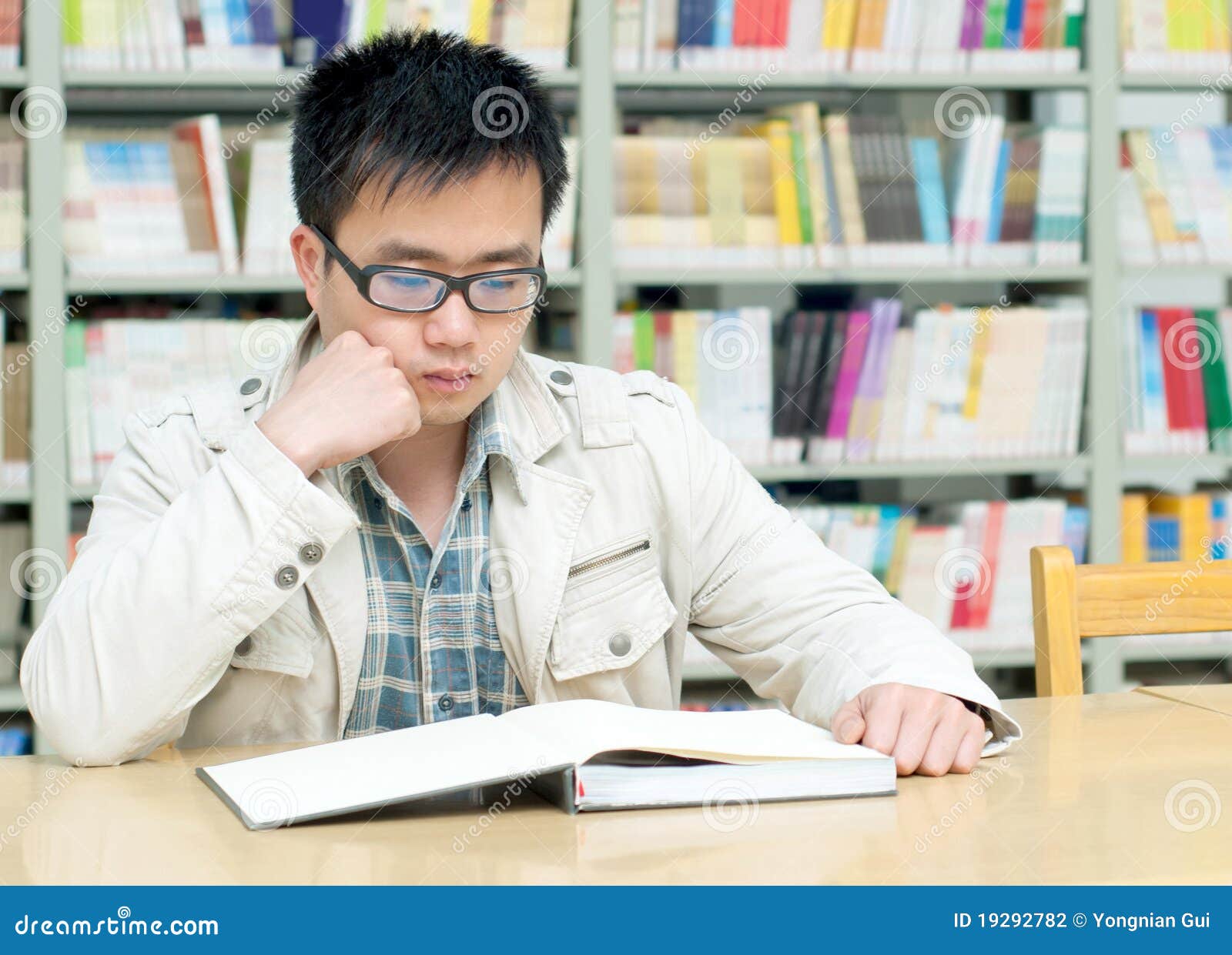 Handsome Man Sitting and Reading in Library Stock Photo - Image of ...