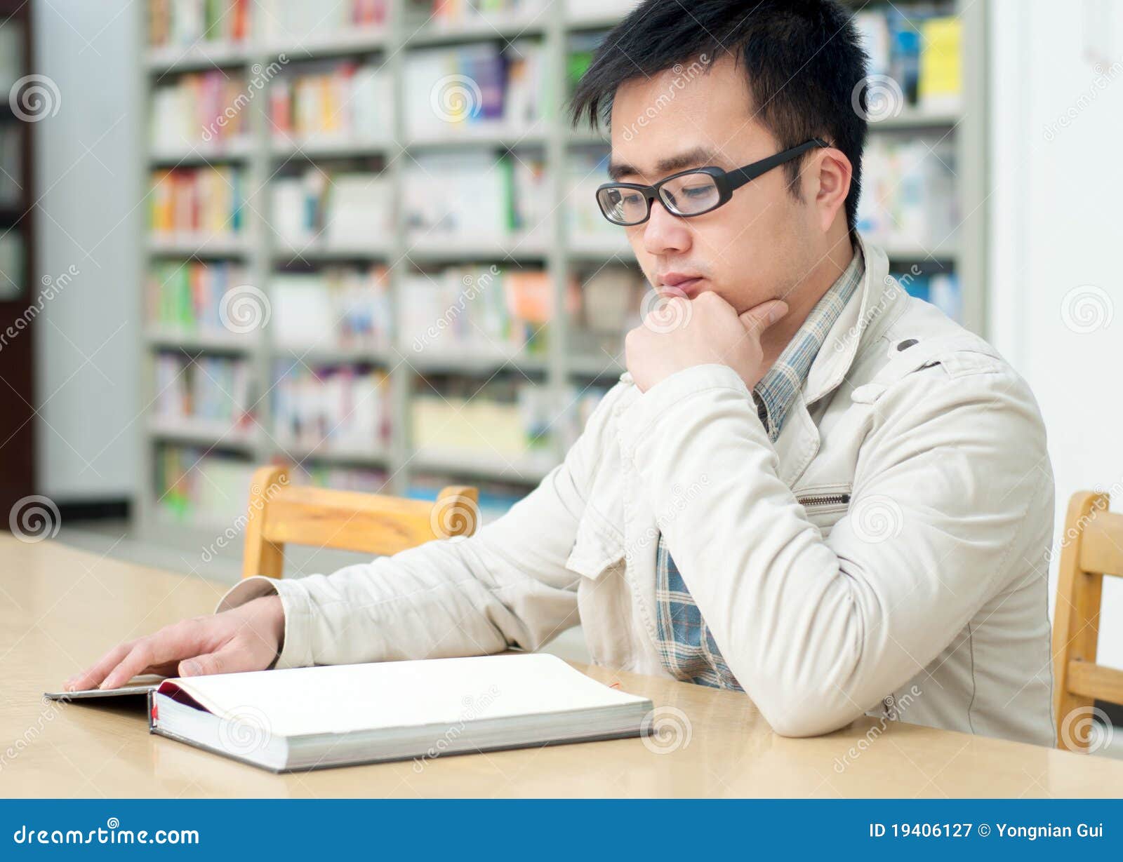 Handsome Man Sitting and Reading in Library Stock Image - Image of hair ...