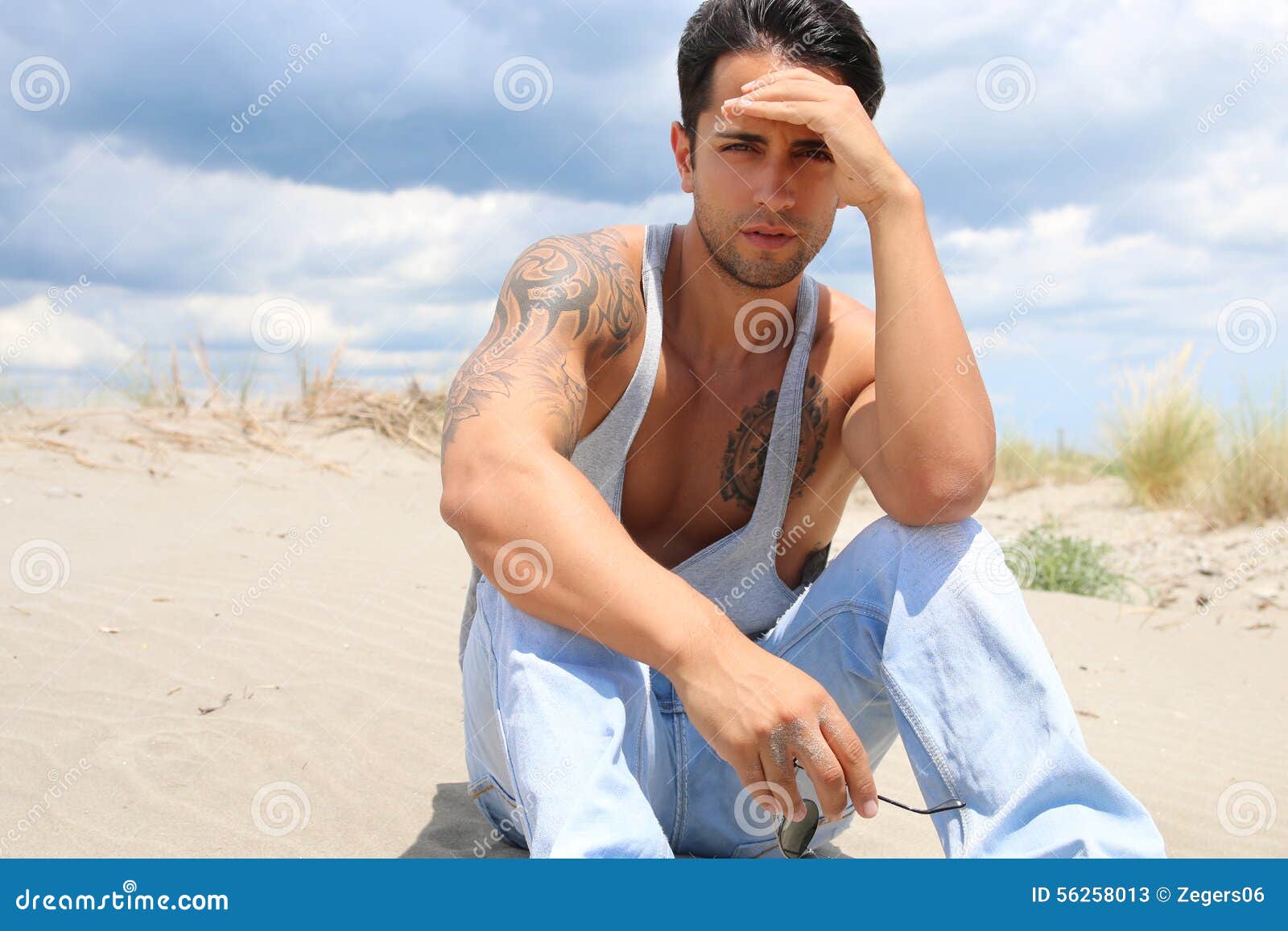 Handsome Man Sitting on the Sand Stock Image - Image of male, face ...