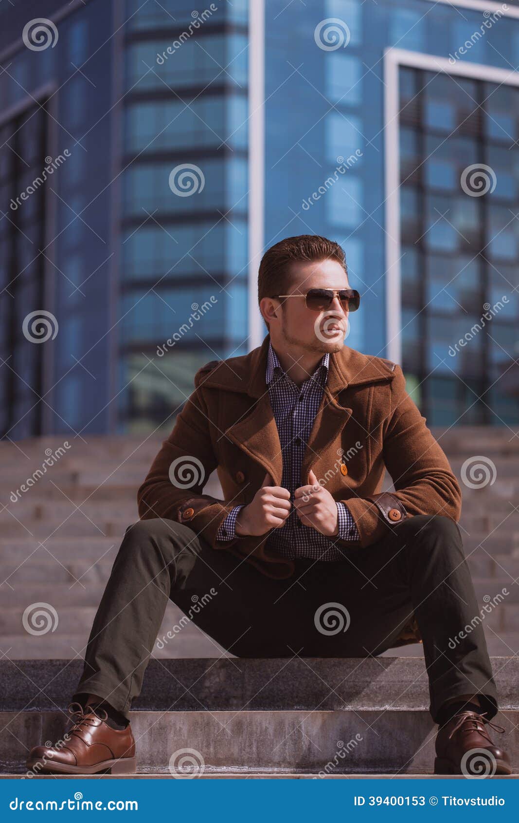 Handsome Man is Sitting on a Skyscraper Background Stock Image - Image ...