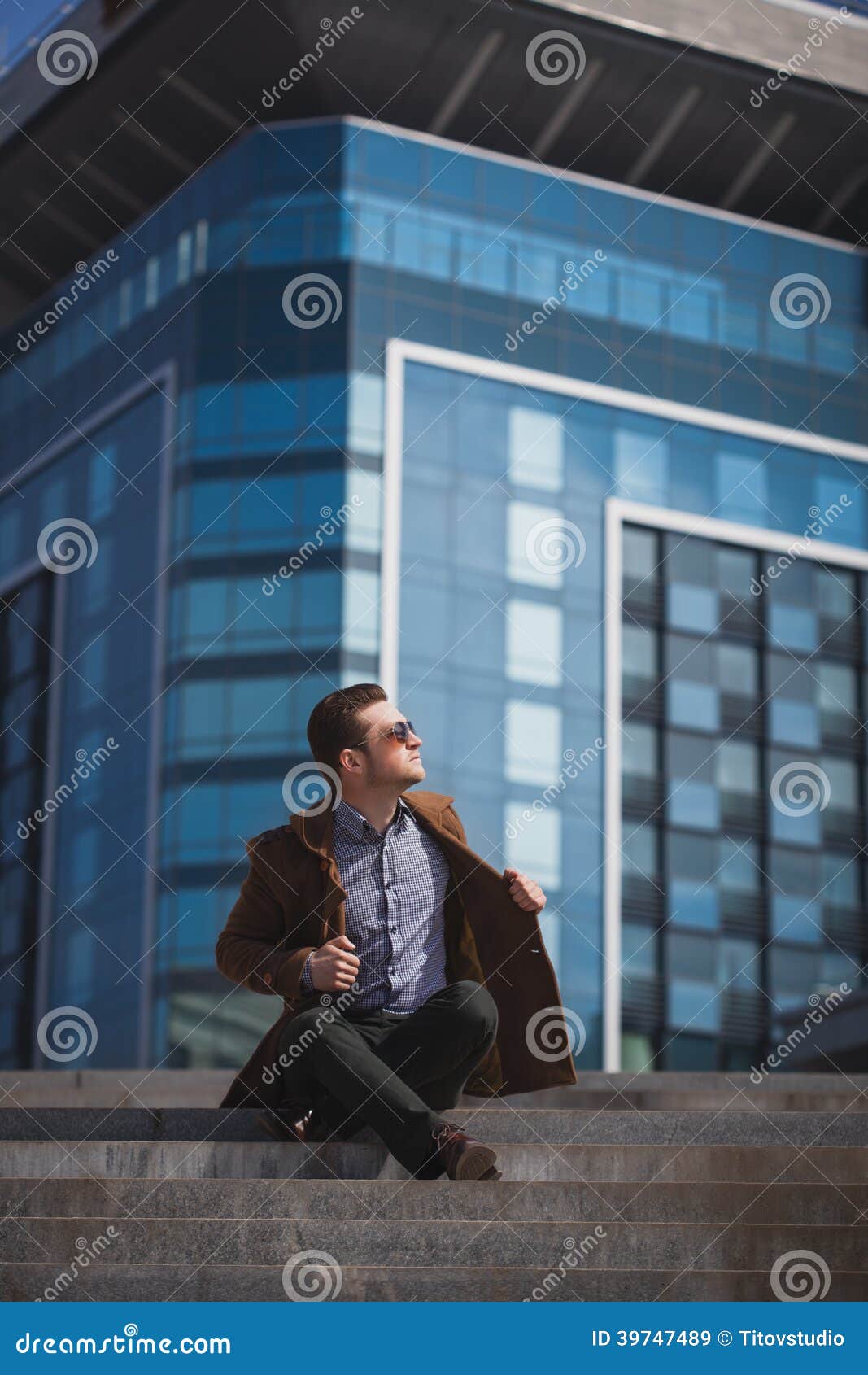 Handsome Man is Sitting on a Skyscraper Background Stock Image - Image ...