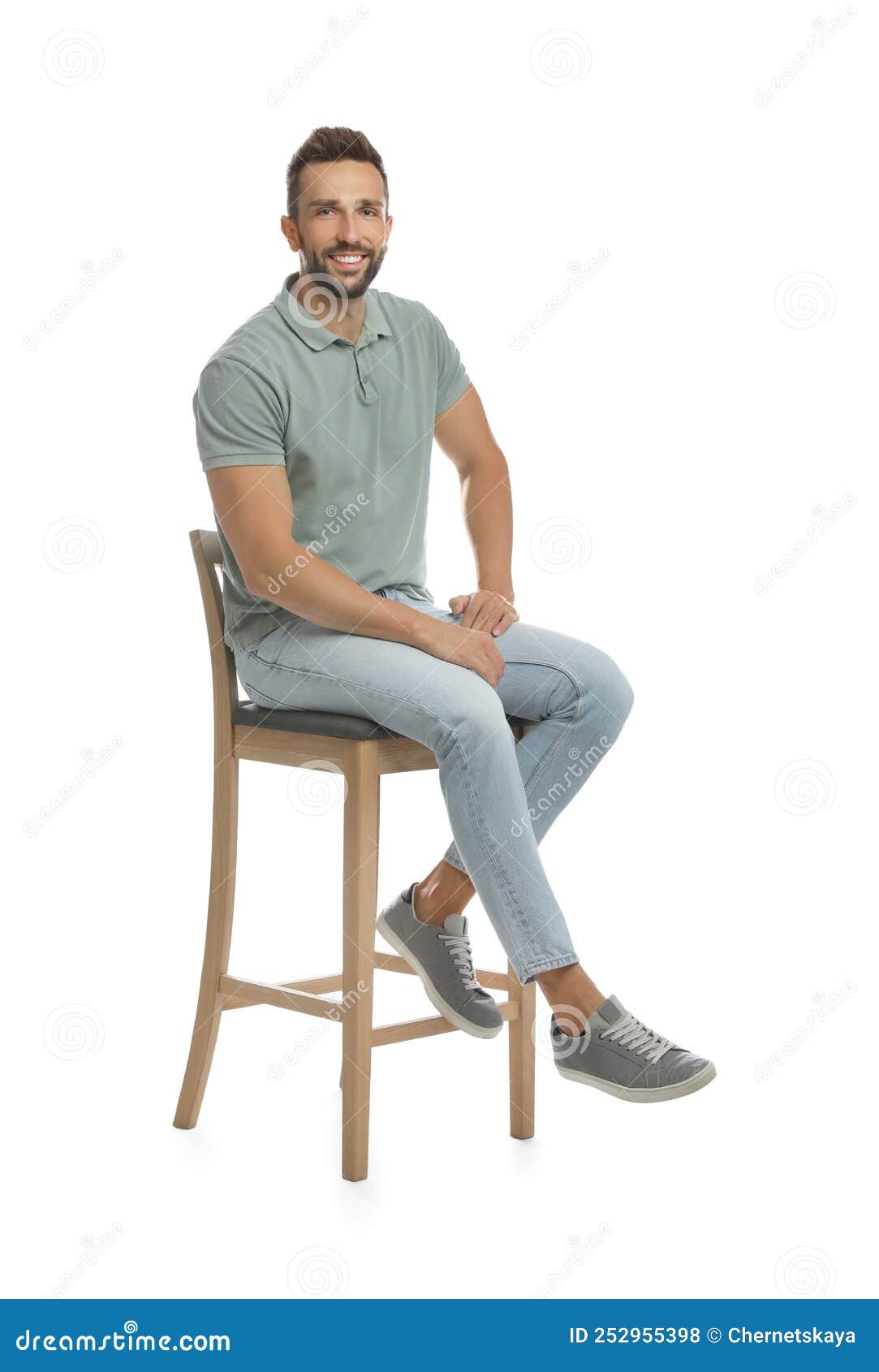 Handsome Man Sitting on Stool Against White Background Stock Photo ...