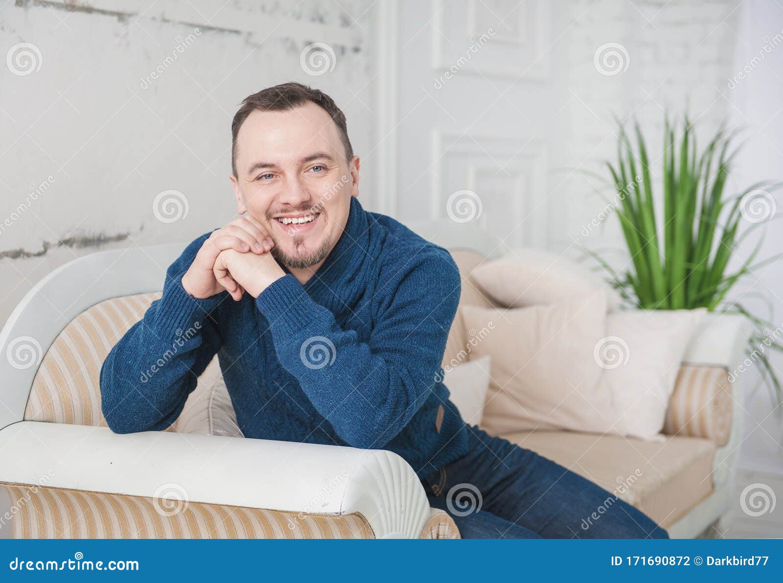 Handsome Man Smile Sitting on Coach at Home Stock Photo - Image of ...
