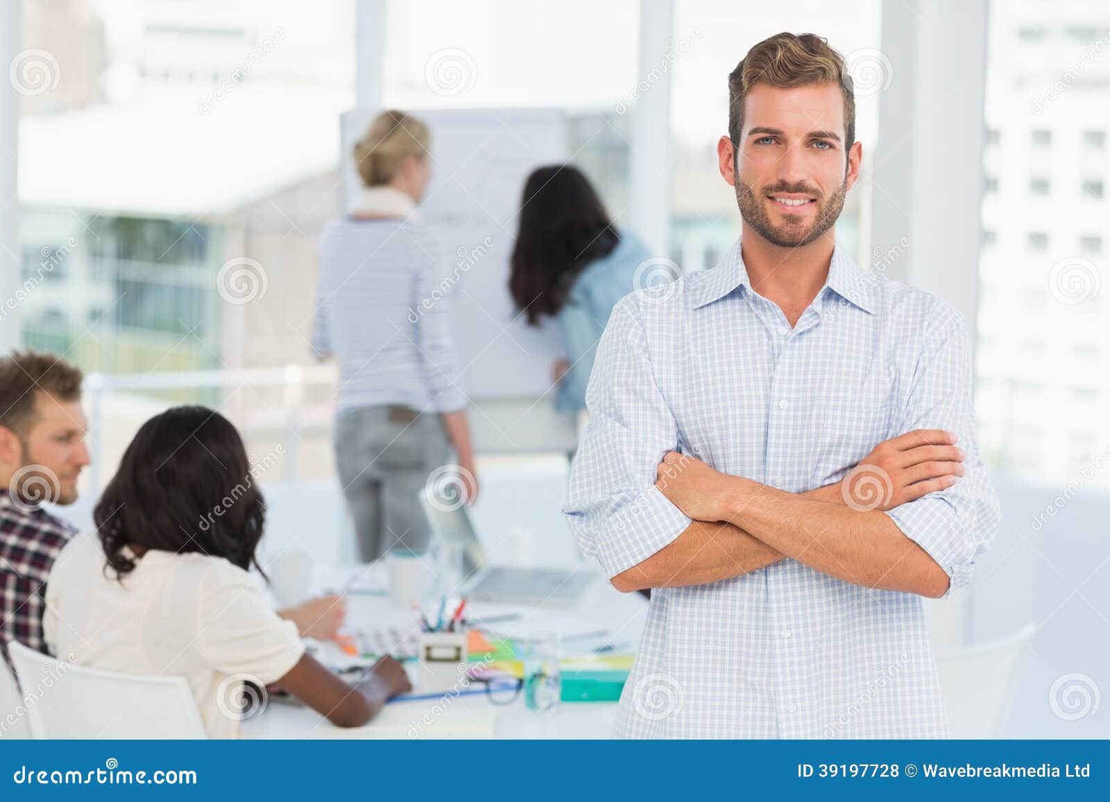 Handsome Man Smiling at Camera while His Colleagues are Working Stock ...