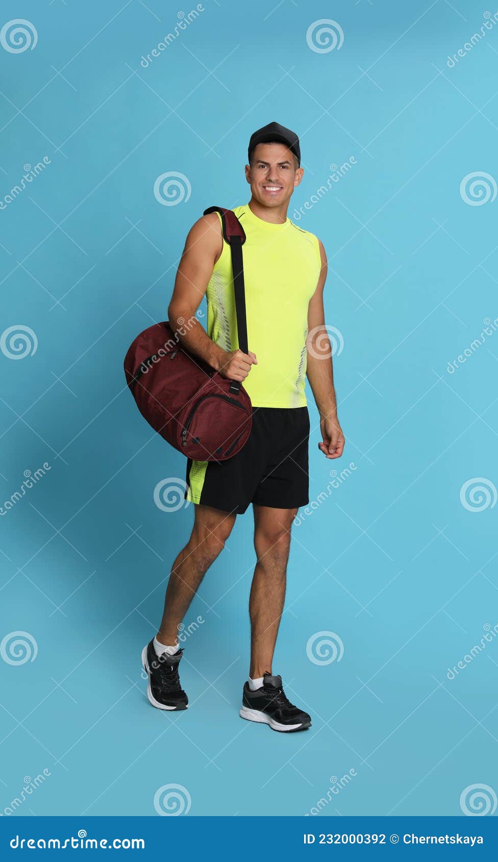 Handsome Man with Sports Bag on Light Blue Background Stock Photo ...