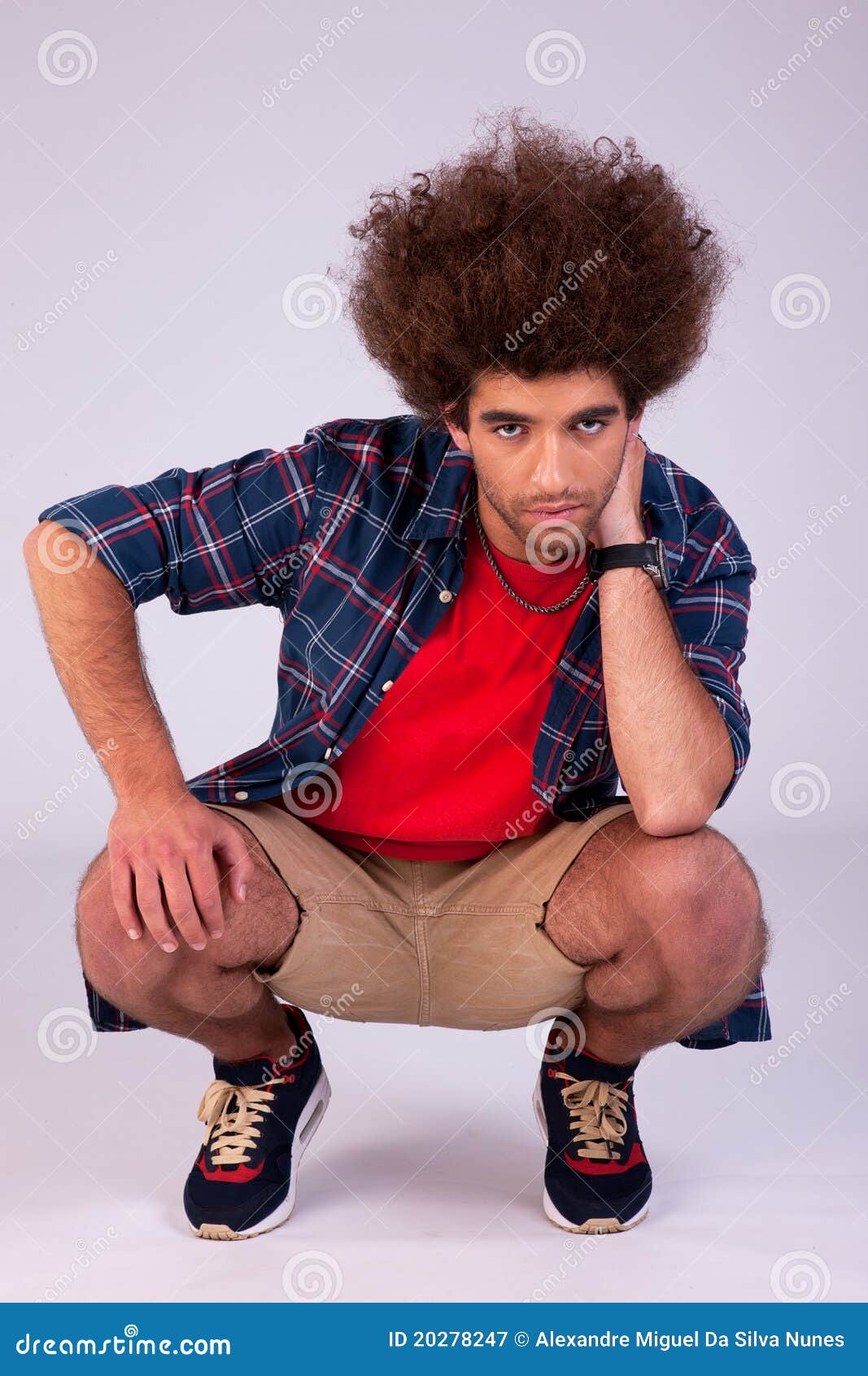 Handsome man squatting stock image. Image of manager - 20278247