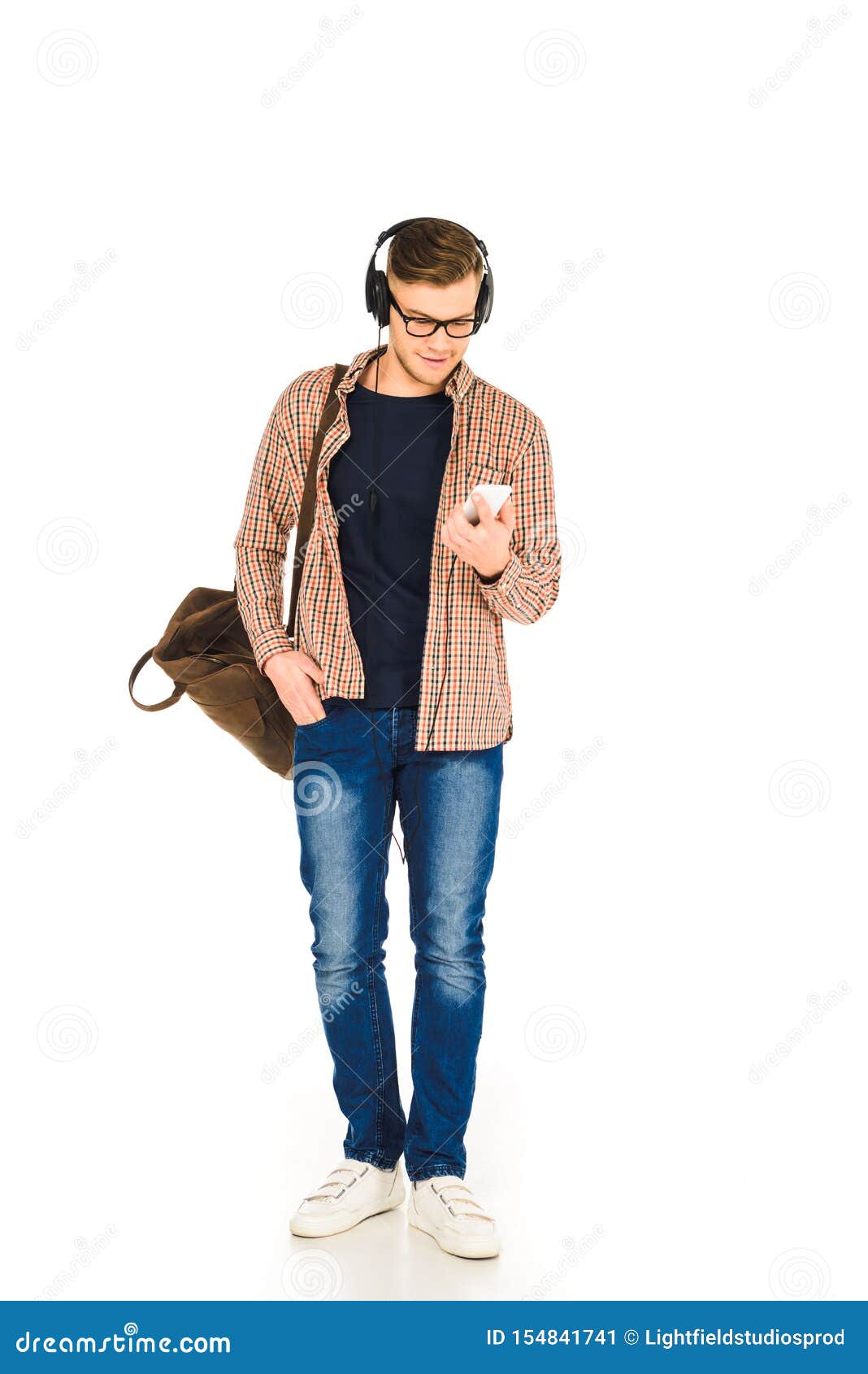 Handsome Man Standing in Headphones and Using Smartphone Isolated Stock ...