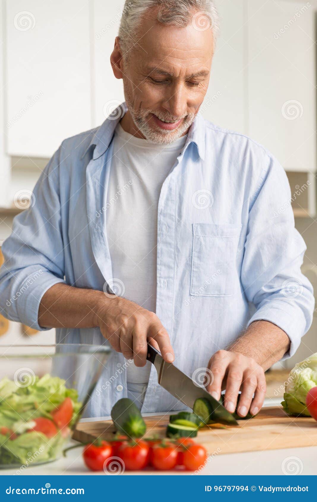 Handsome Man Standing at the Kitchen Using Laptop and Cooking Stock ...