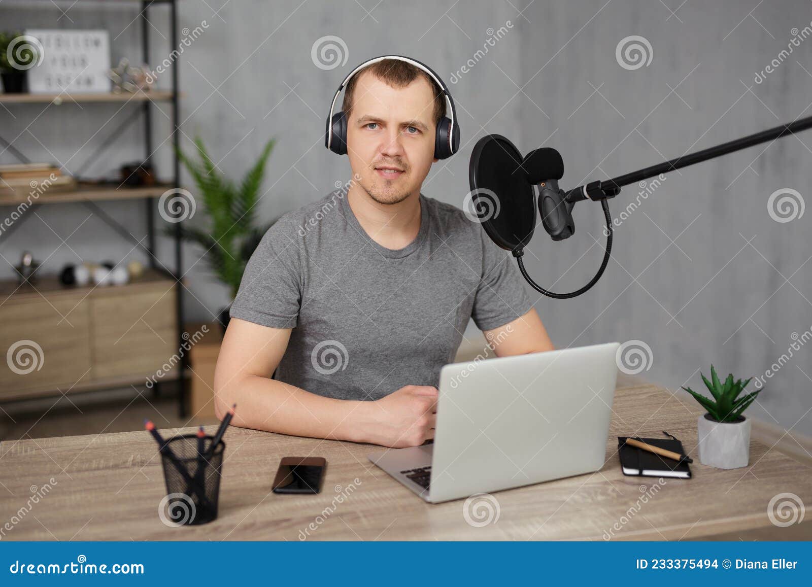 Handsome Man Streaming His Audio Podcast Using Microphone and Laptop ...