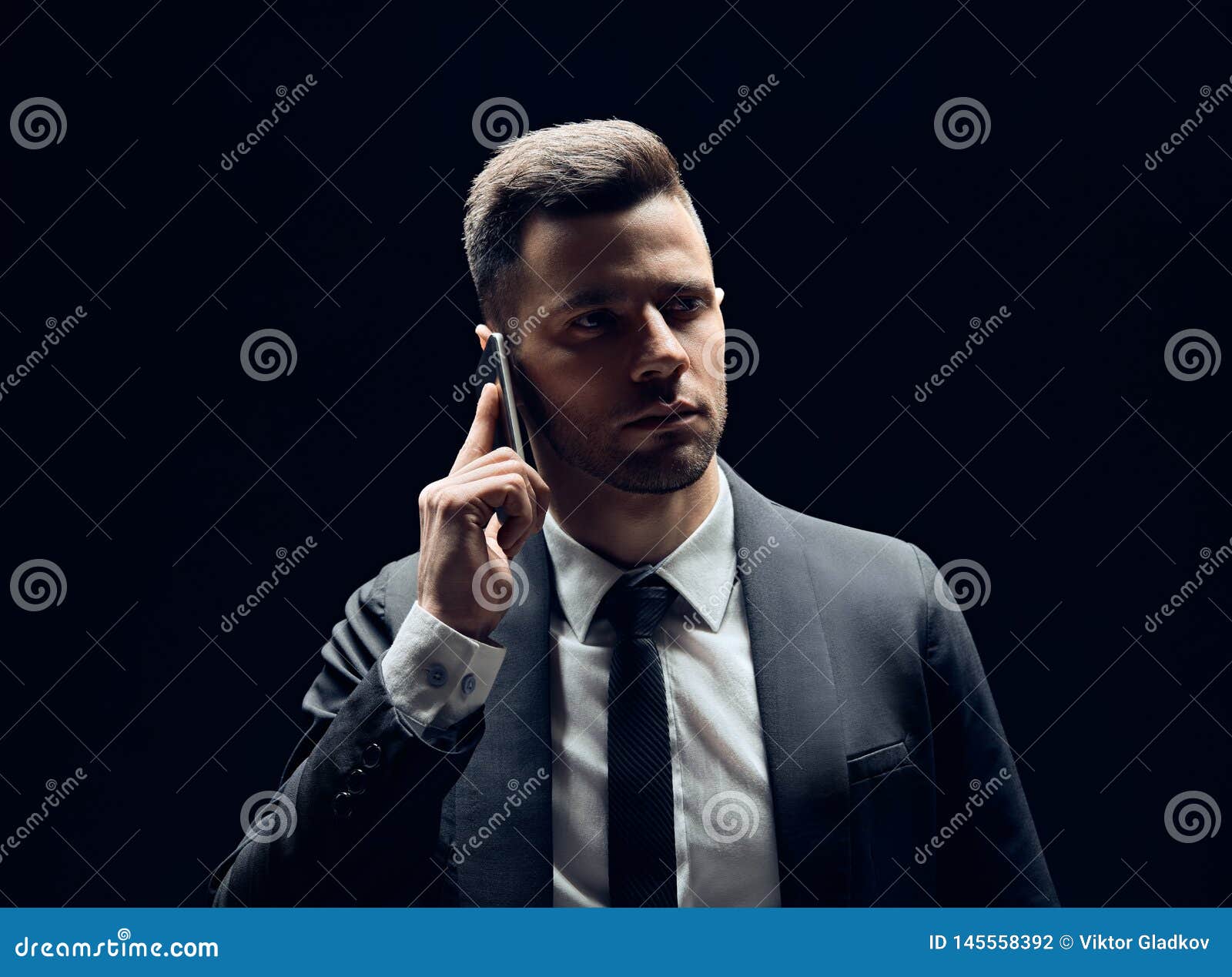 Handsome Man in Suit Talking on Mobile Phone Isolated on Dark ... Handsome Man in Suit Talking on Mobile Phone Isolated on Dark ...