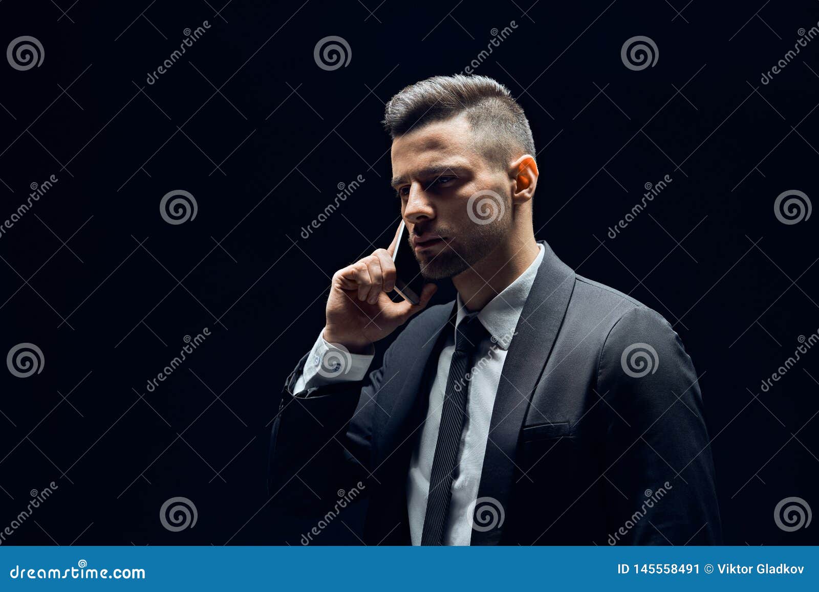 Handsome Man in Suit Talking on Mobile Phone Isolated on Dark ... Handsome Man in Suit Talking on Mobile Phone Isolated on Dark ...