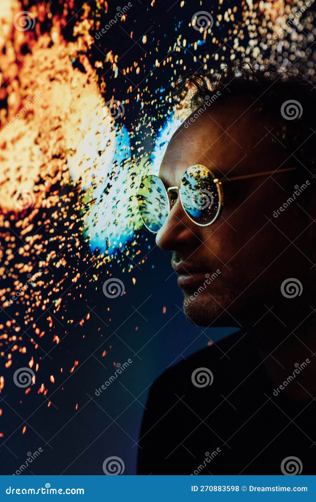 A Handsome Man in Sunglasses Next To Bright Led Lights Stock Photo ...