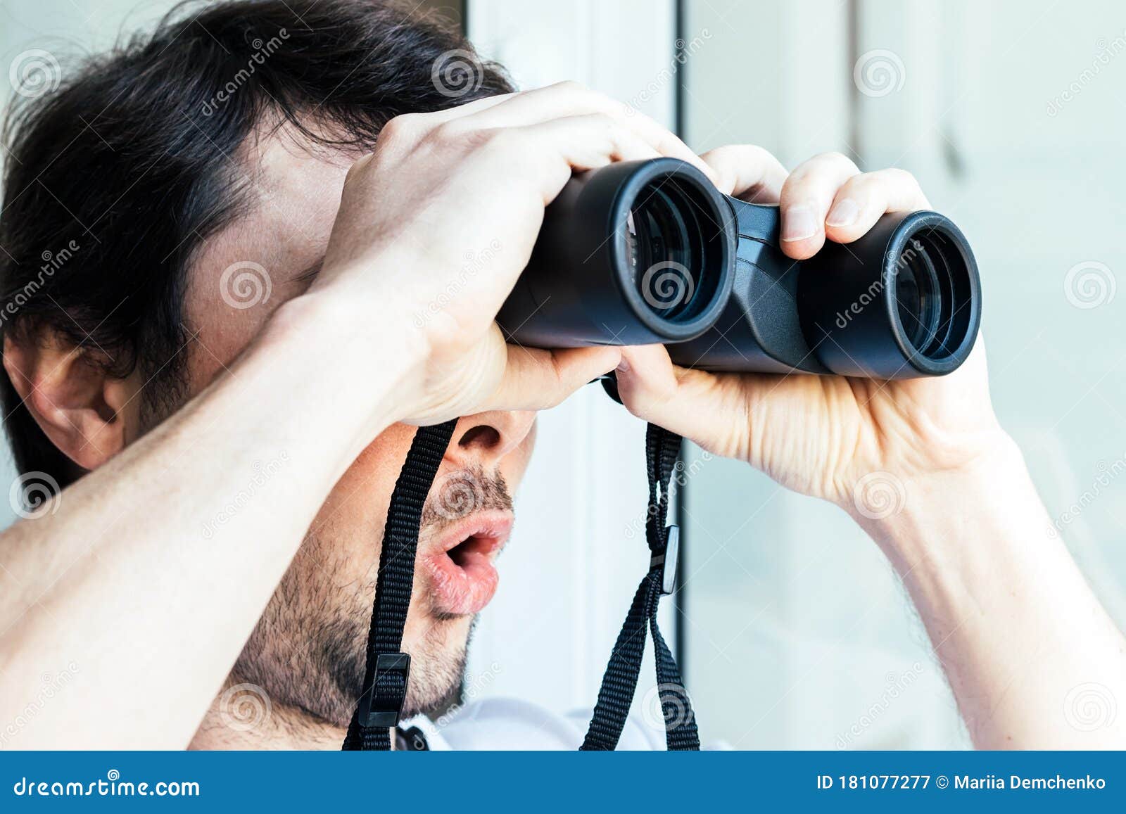 Handsome Man with a Surprised Face Looking through Binoculars at the ...