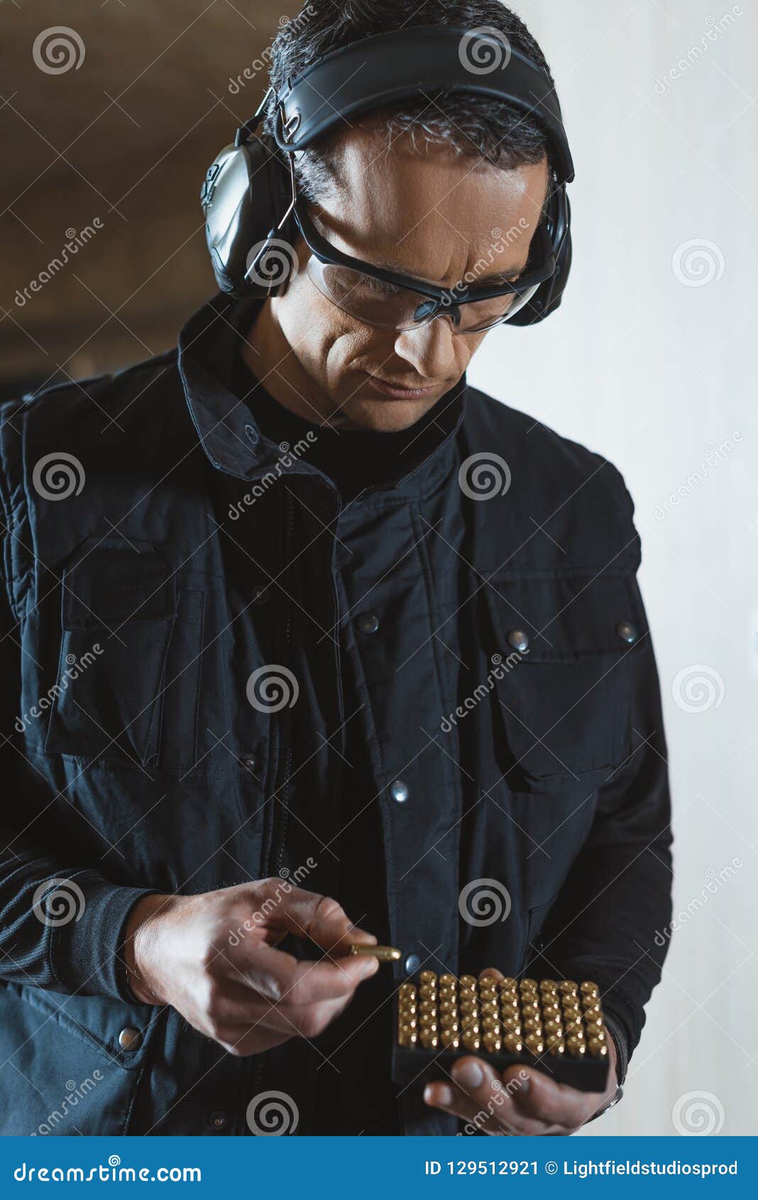 Handsome man taking bullet stock image. Image of shootinggallery ...