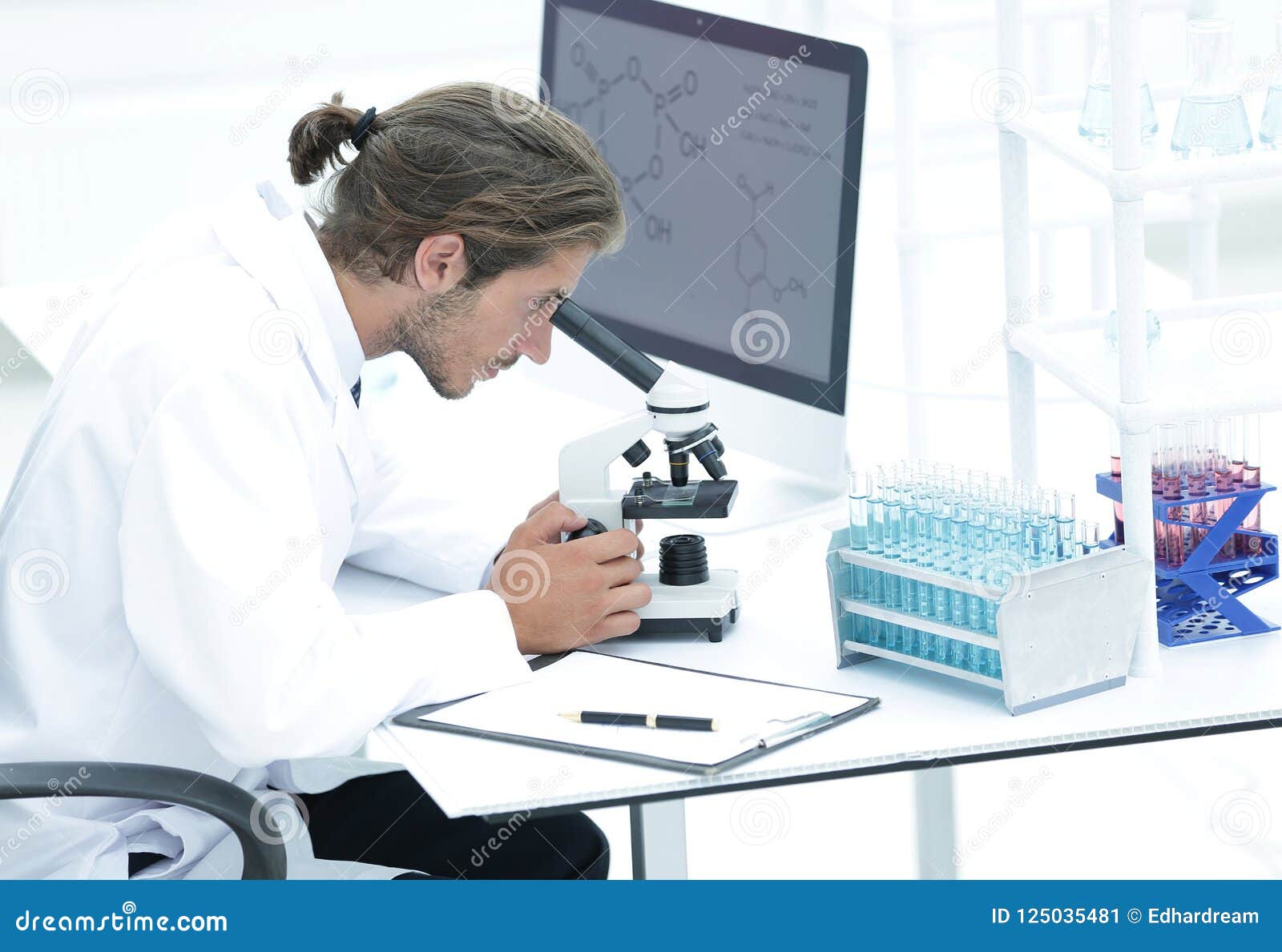 A Handsome Man Technician in the Lab Looking through Microscope Stock ...
