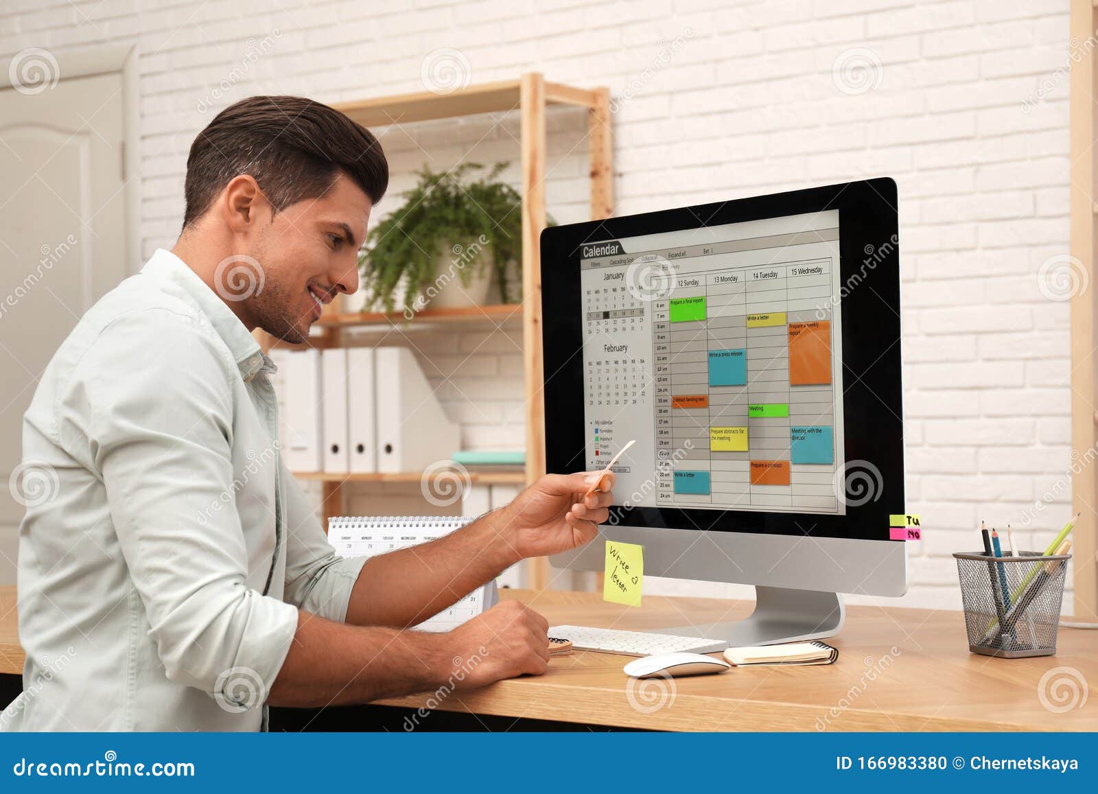 Handsome Man Using Calendar App on Computer Stock Photo - Image of ...