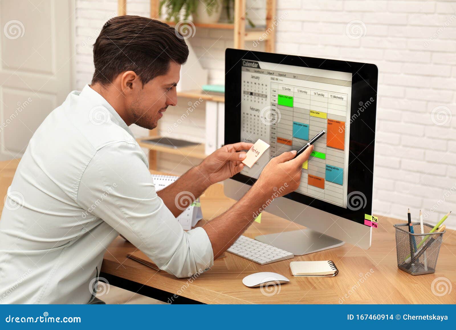 Handsome Man Using Calendar App on Computer Stock Photo - Image of ...