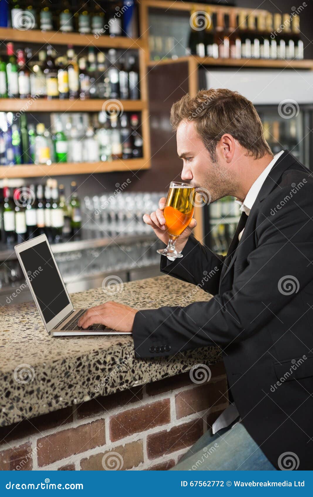 Handsome Man Using Laptop Computer and Drinking a Beer Stock Photo ...
