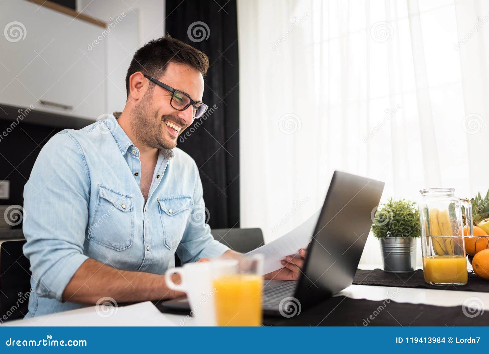 Handsome Man Using Laptop Computer at Home, Drinking Juice and Coffee ...