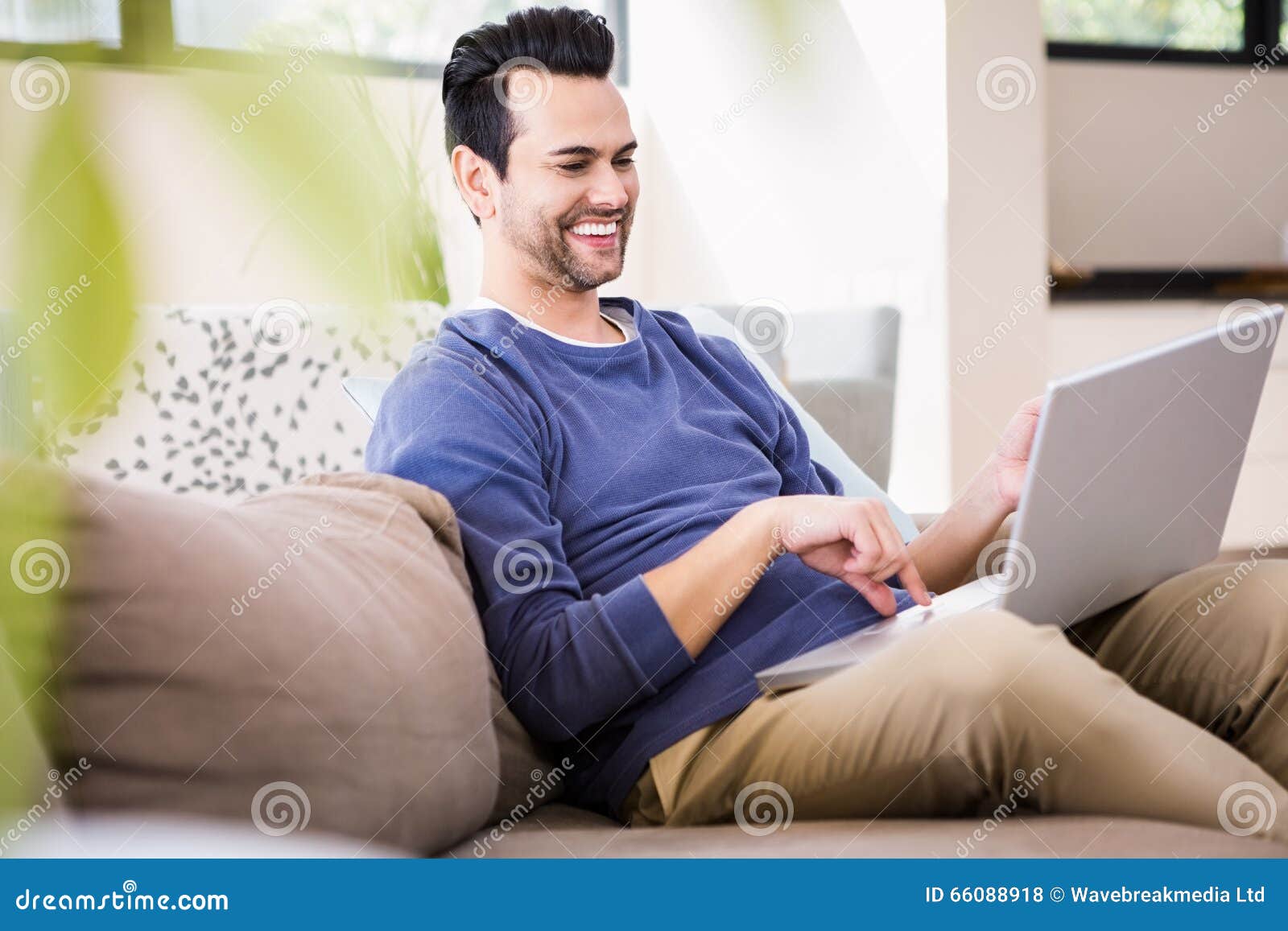 Handsome Man Using Laptop on Couch Stock Photo - Image of laptop ...