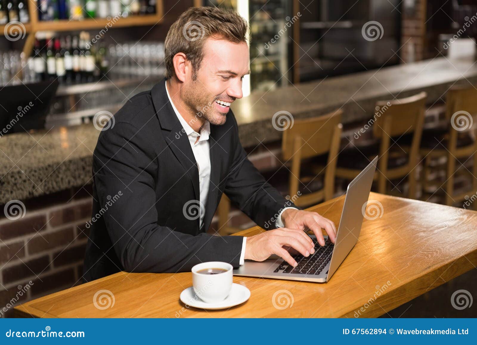 Handsome Man Using Laptop and Having a Coffee Stock Photo - Image of ...