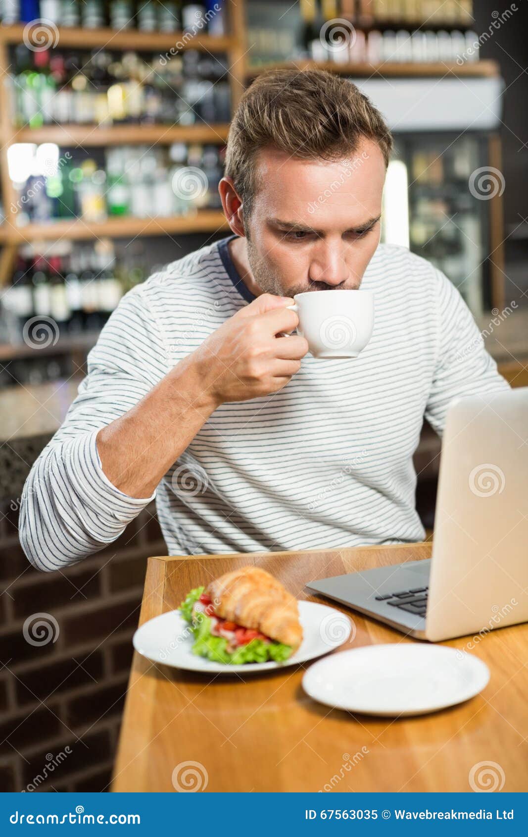 Handsome Man Using Laptop and Having a Coffee Stock Image - Image of ...