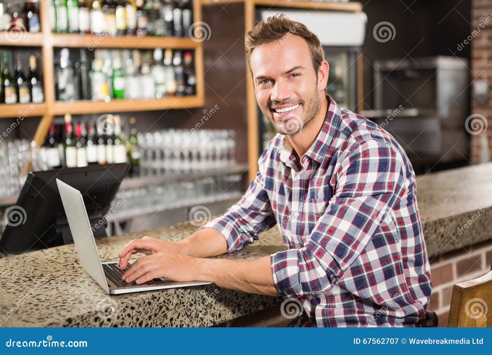 Handsome man using laptop stock image. Image of time - 67562707