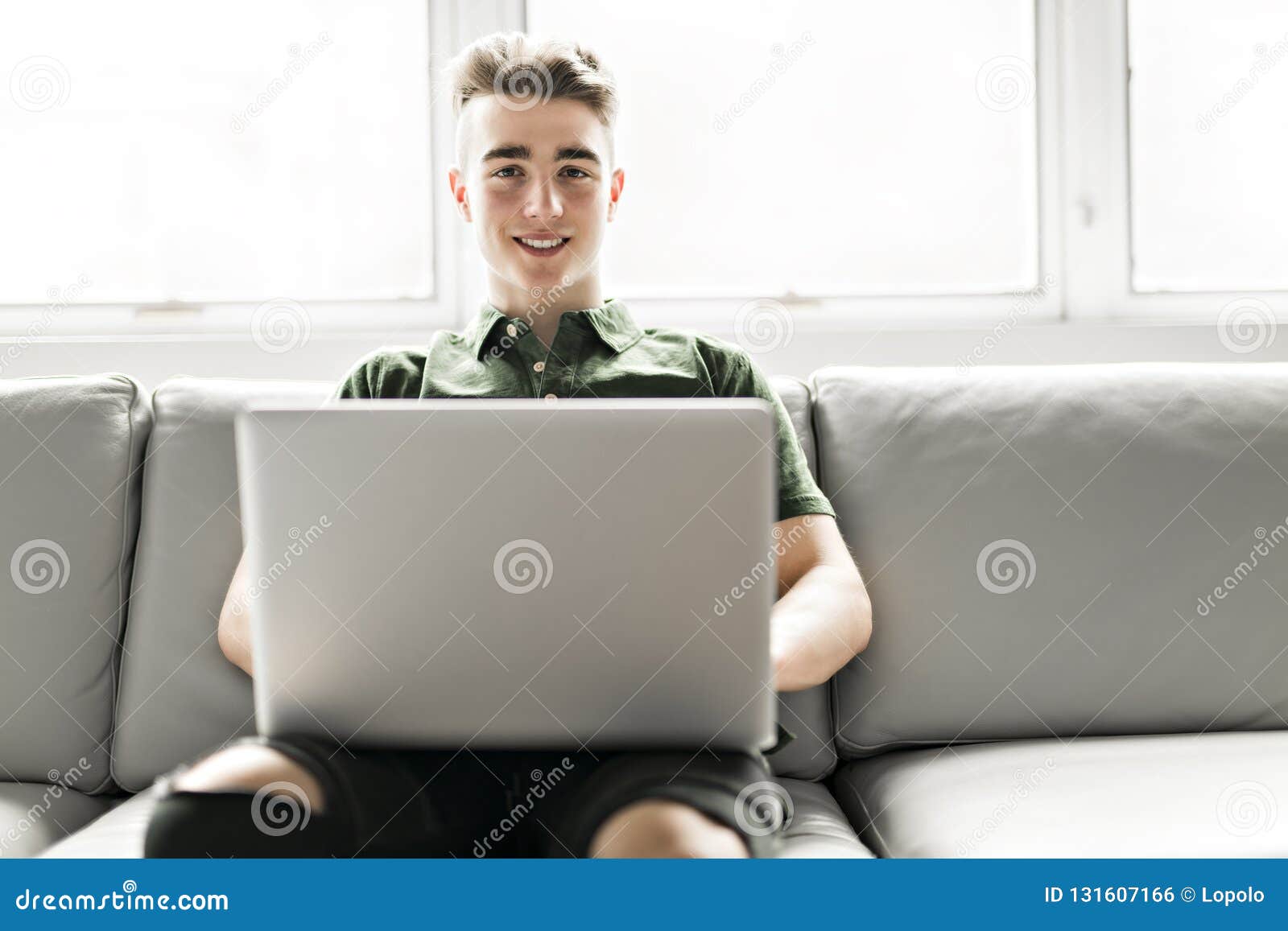 Handsome Man Using a Laptop Sitting on Couch at Home Stock Photo ...