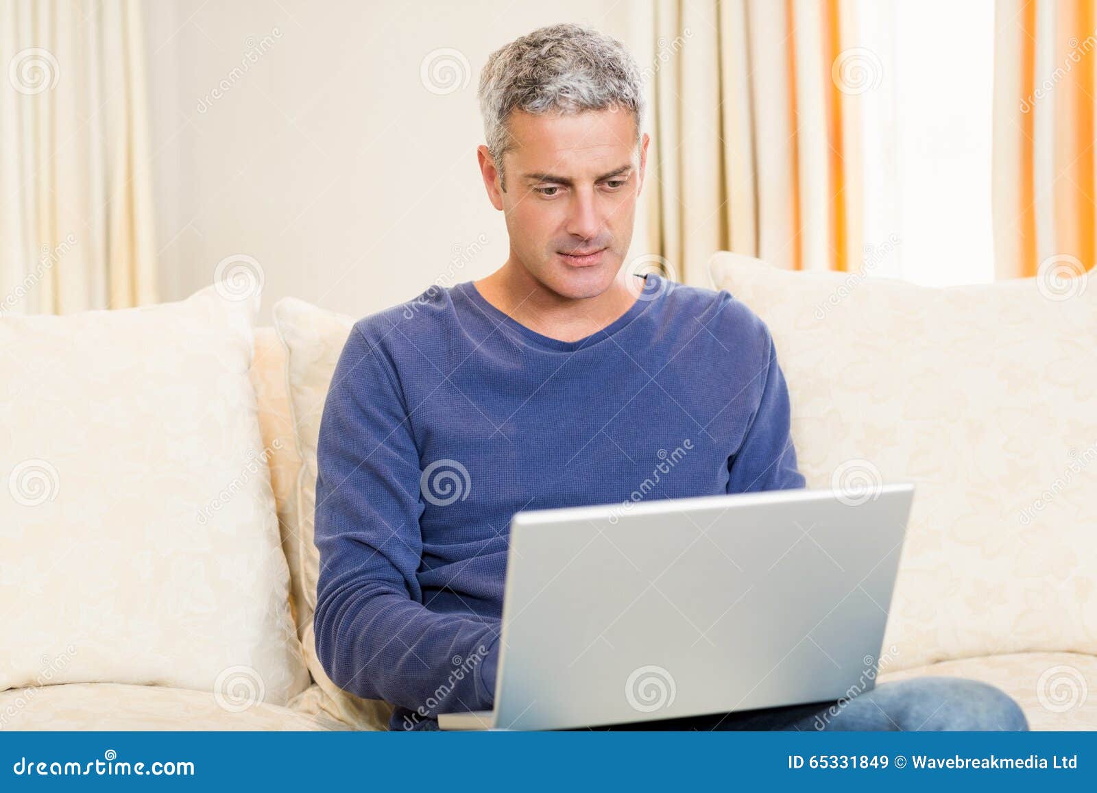 Handsome man using laptop stock image. Image of homey - 65331849