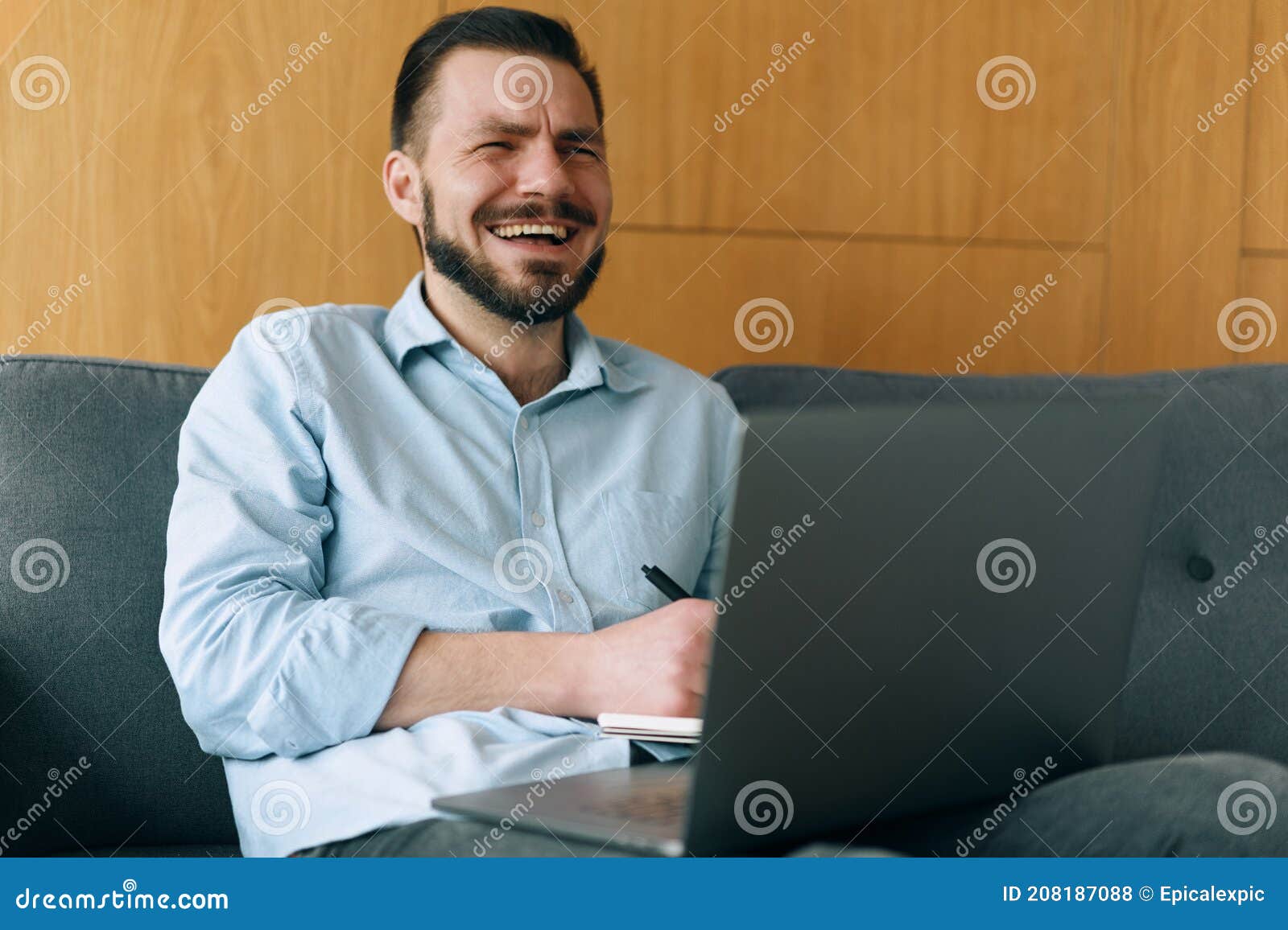 Handsome Man Using Laptop, Typing on Keyboard and Laughing Stock Photo ...