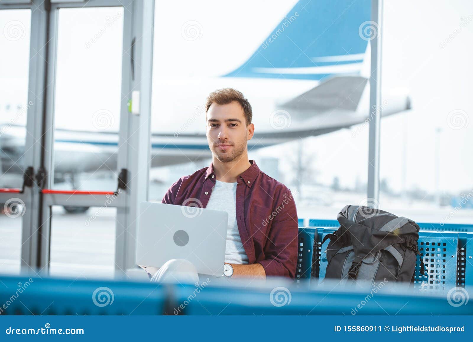 Handsome Man Using Laptop while Waiting Stock Image - Image of person ...