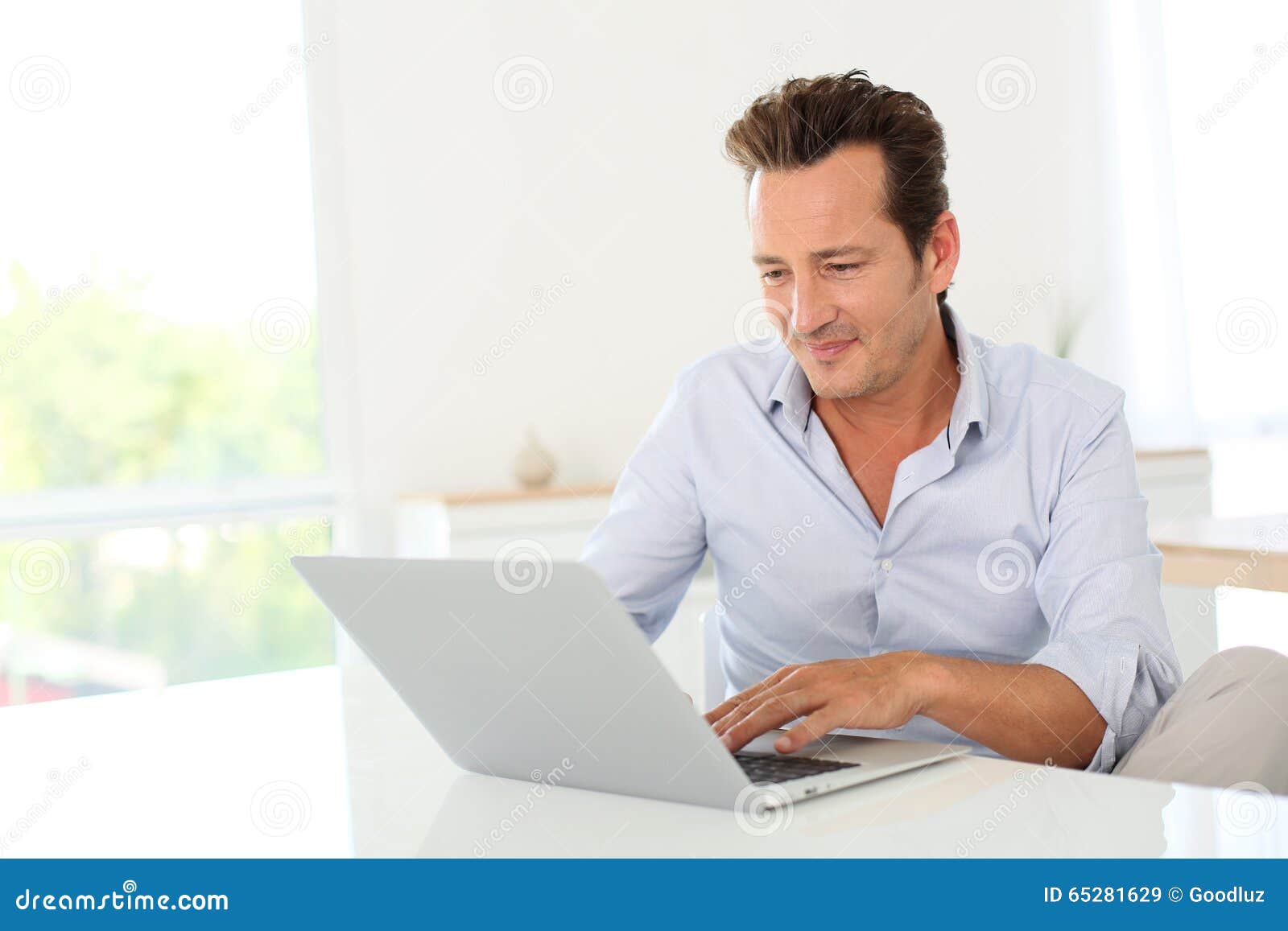 Handsome man using laptop stock image. Image of laptop - 65281629