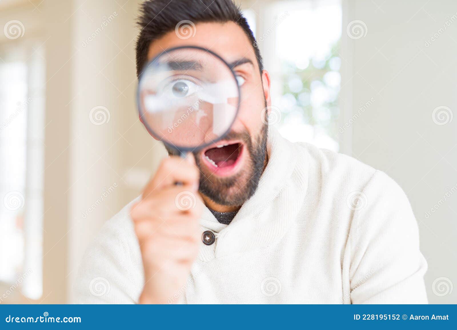 Handsome Man Using Magnifying Glass, Doing Funny Faces Stock Photo ...