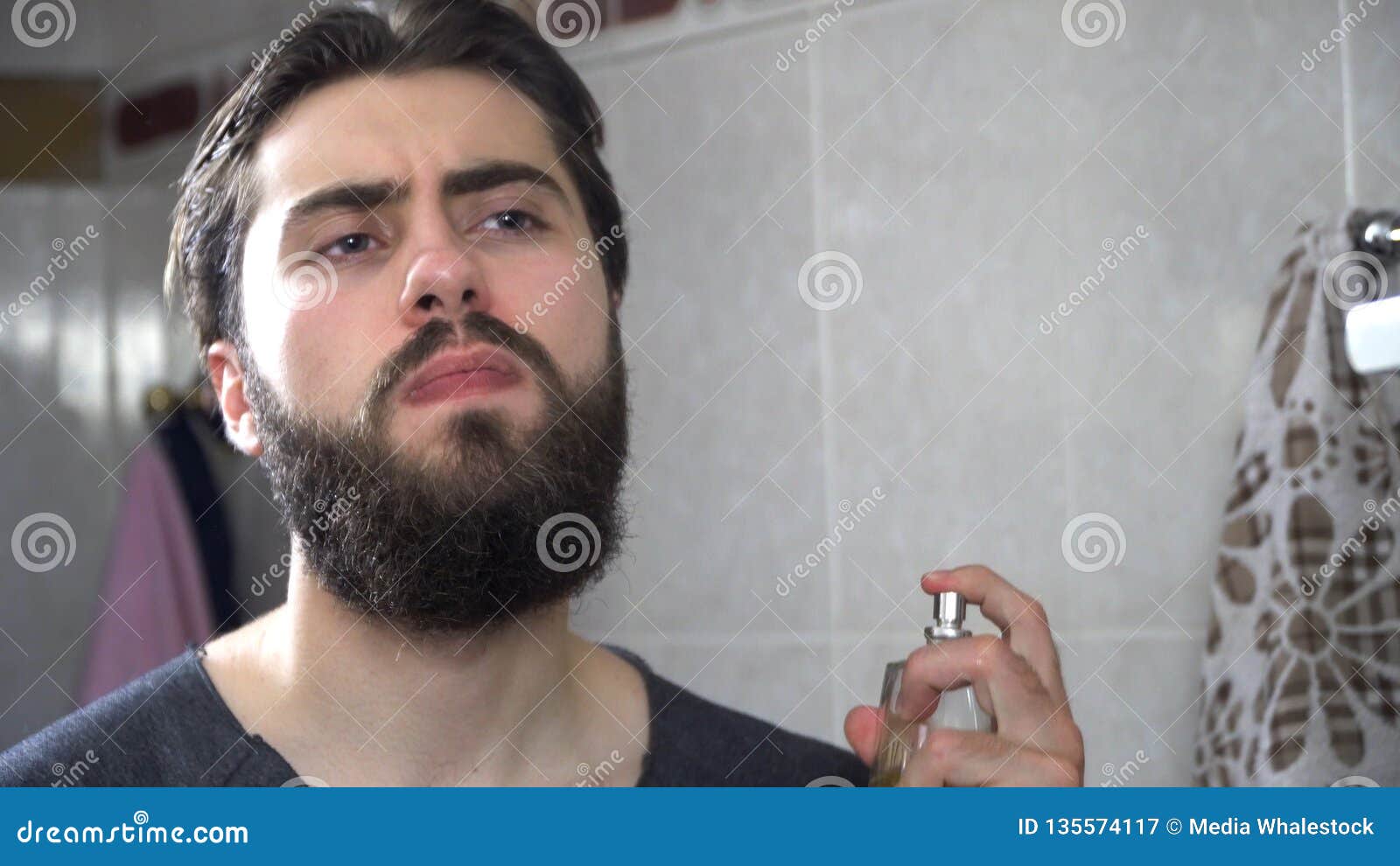 Handsome Man Using Perfume in Front of Mirror. Handsome Man Applying ...