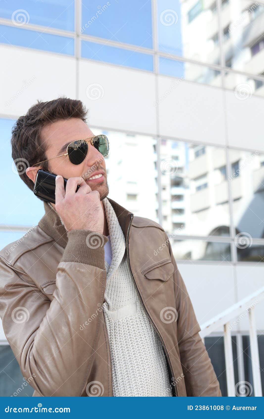 Handsome man using a phone stock photo. Image of building - 23861008