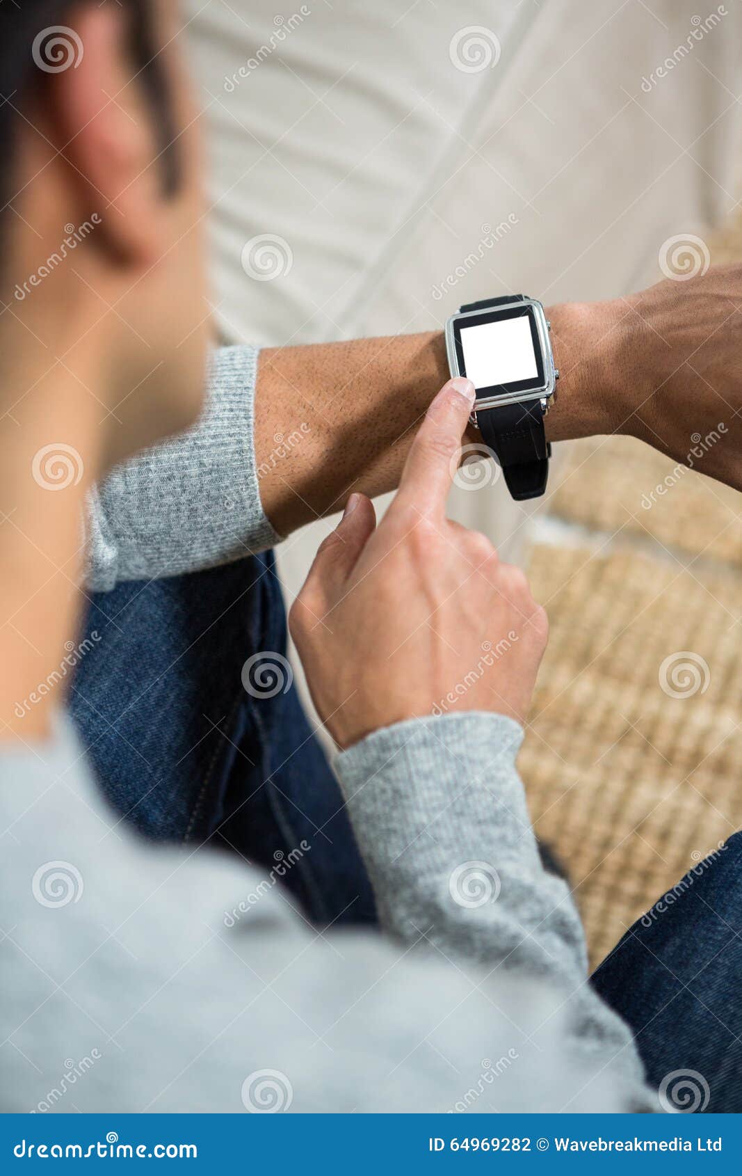 Handsome Man Using Smartwatch on the Sofa Stock Photo - Image of couch ...