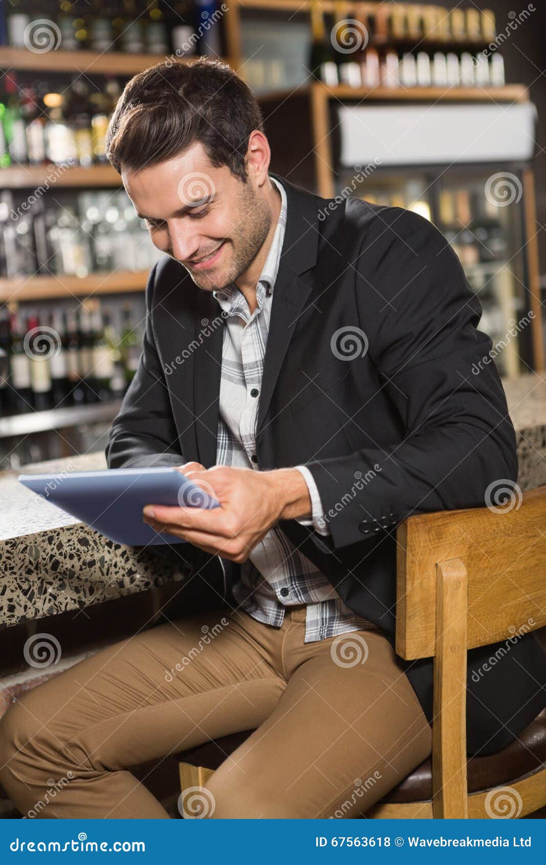 Handsome man using tablet stock photo. Image of happy - 67563618