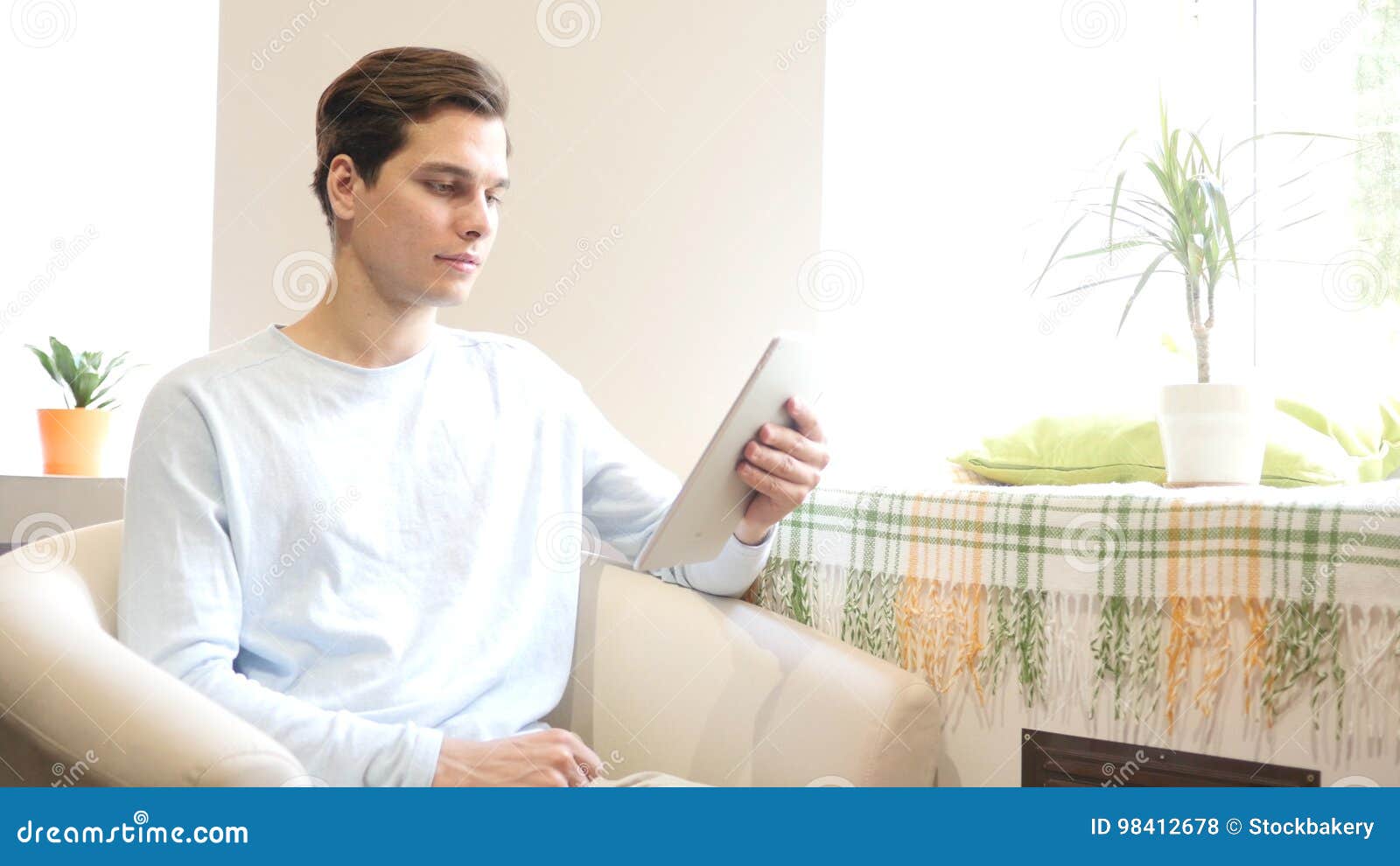 Handsome Man Watching Video on Tablet Stock Photo - Image of modern ...