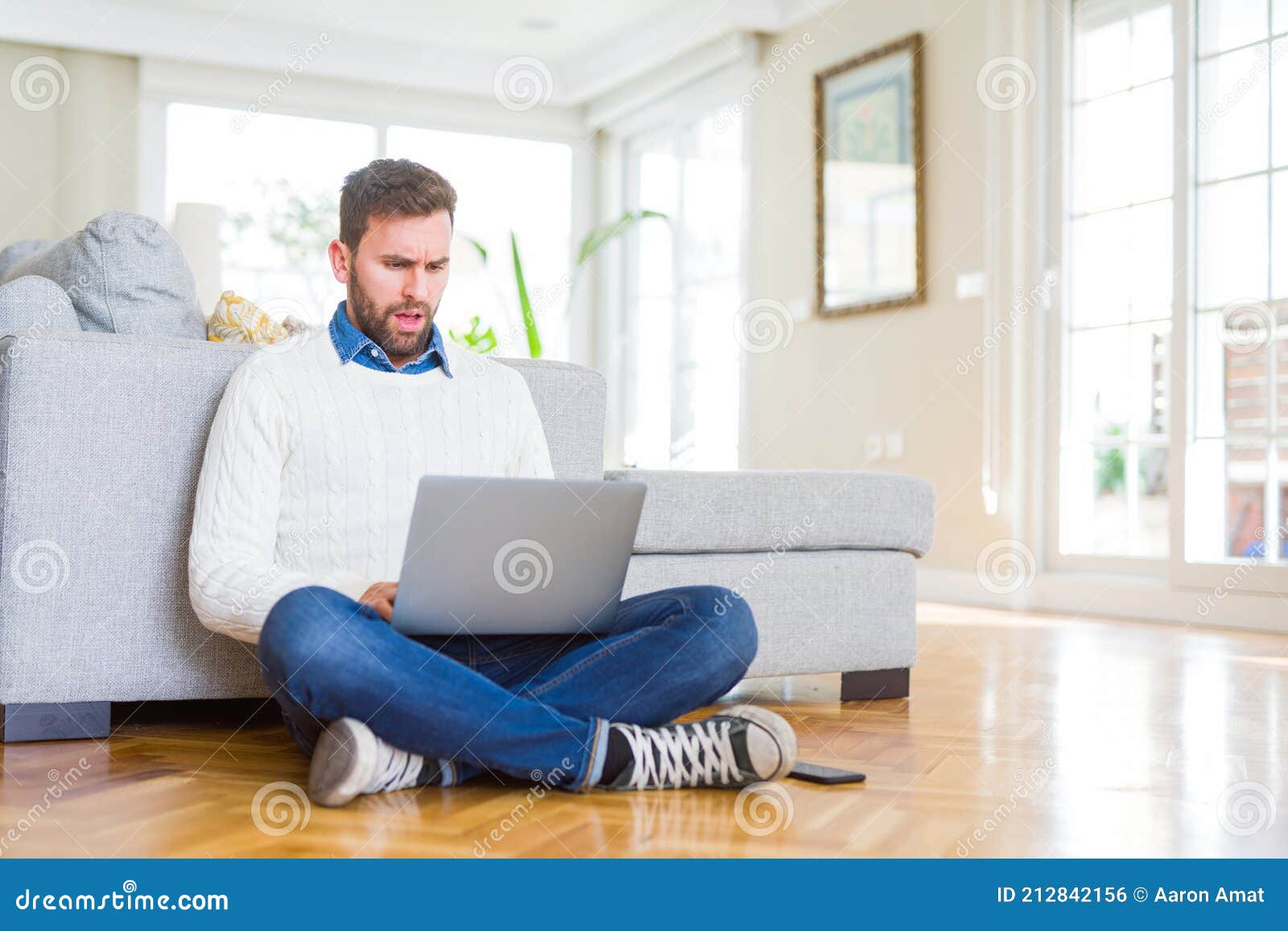 Handsome Man Wearing Working Using Computer Laptop Scared in Shock with ...